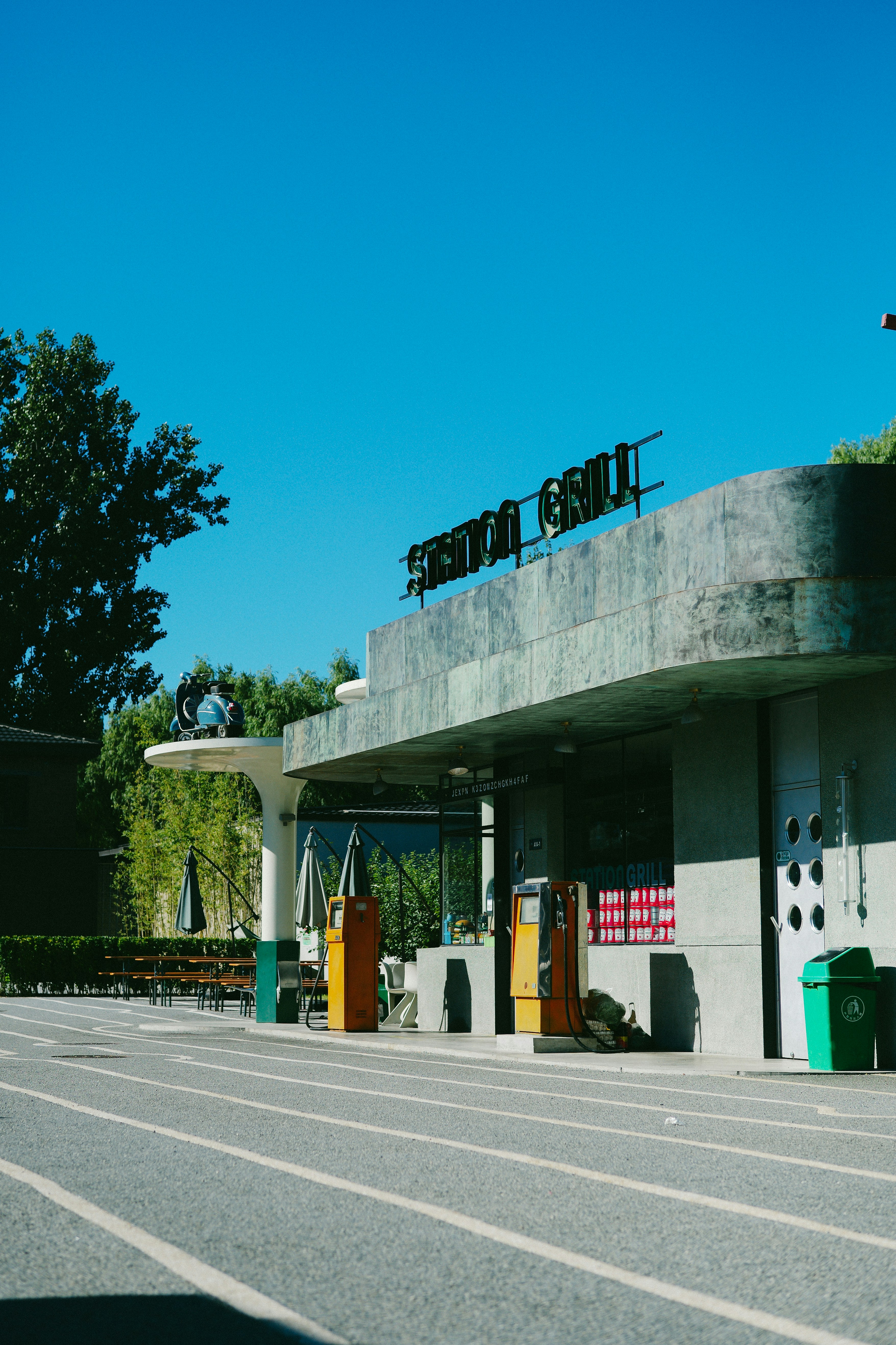 Blue Sky Over a Concrete Grillfront: A Quiet Retro Drive-In Exterior