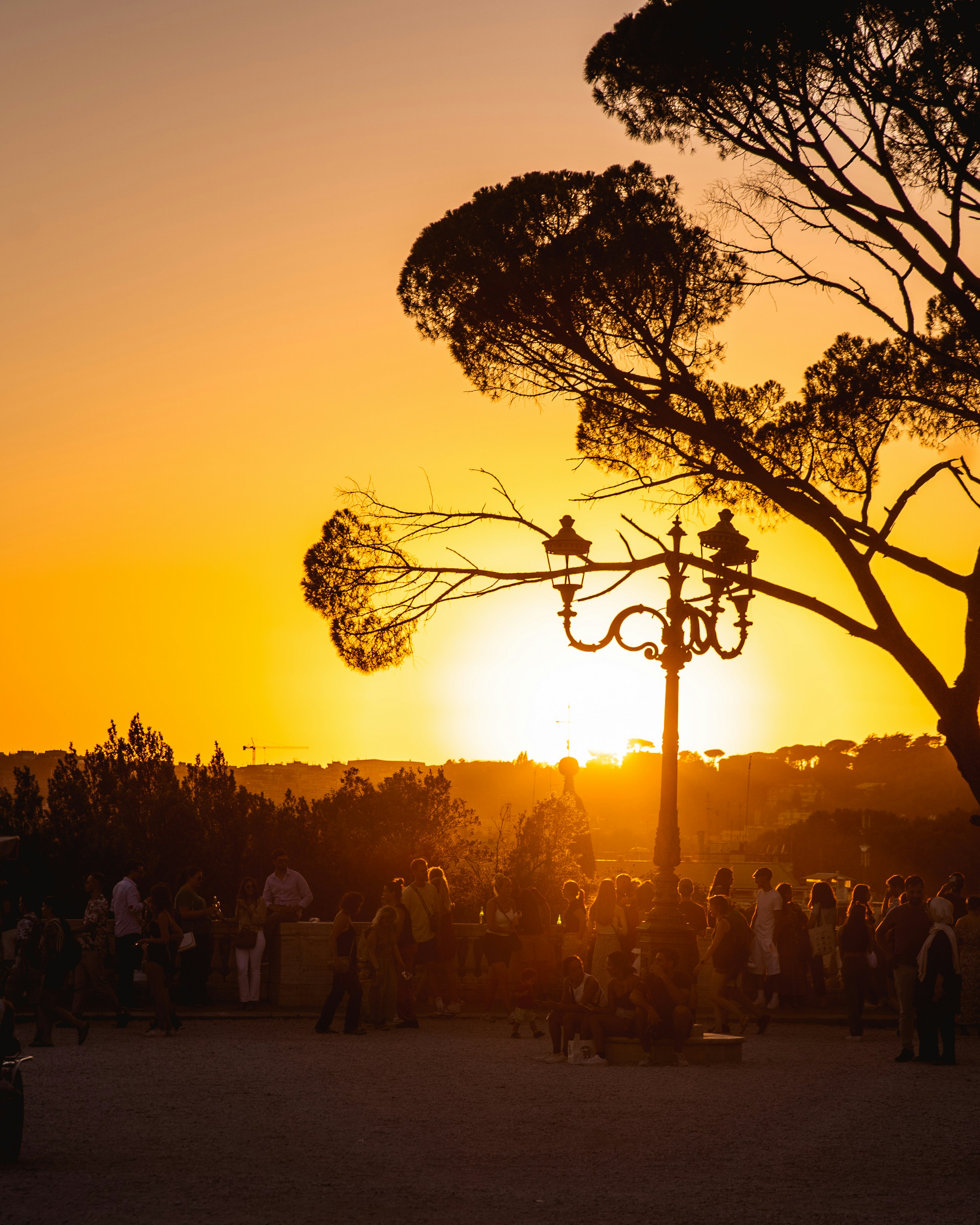 Golden Hour Lantern: Sunset Silhouette in a Crowded Square