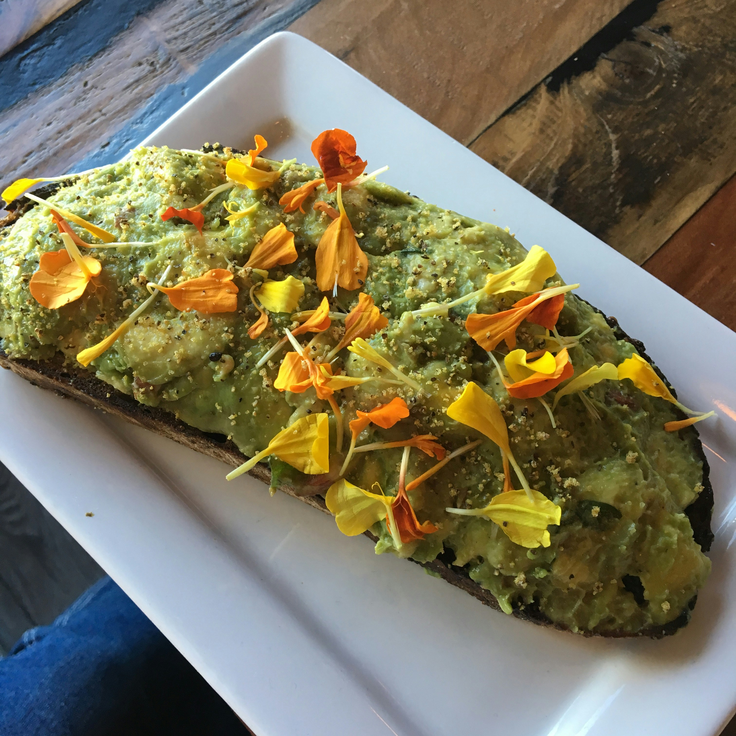 Verdant Avo-Toast: Herbaceous Green Spread Topped with Edible Flowers