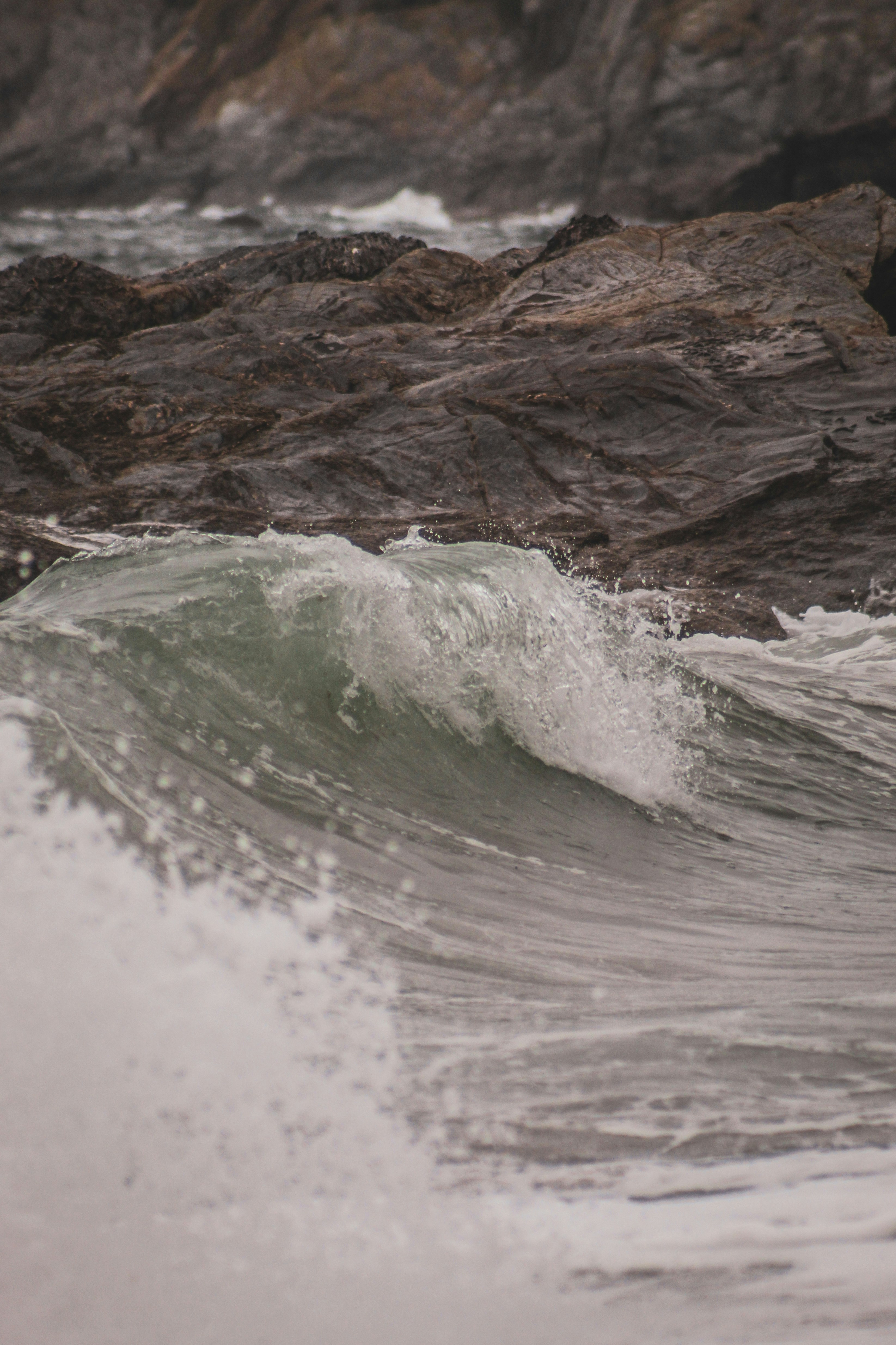 a wave crashing against a rock