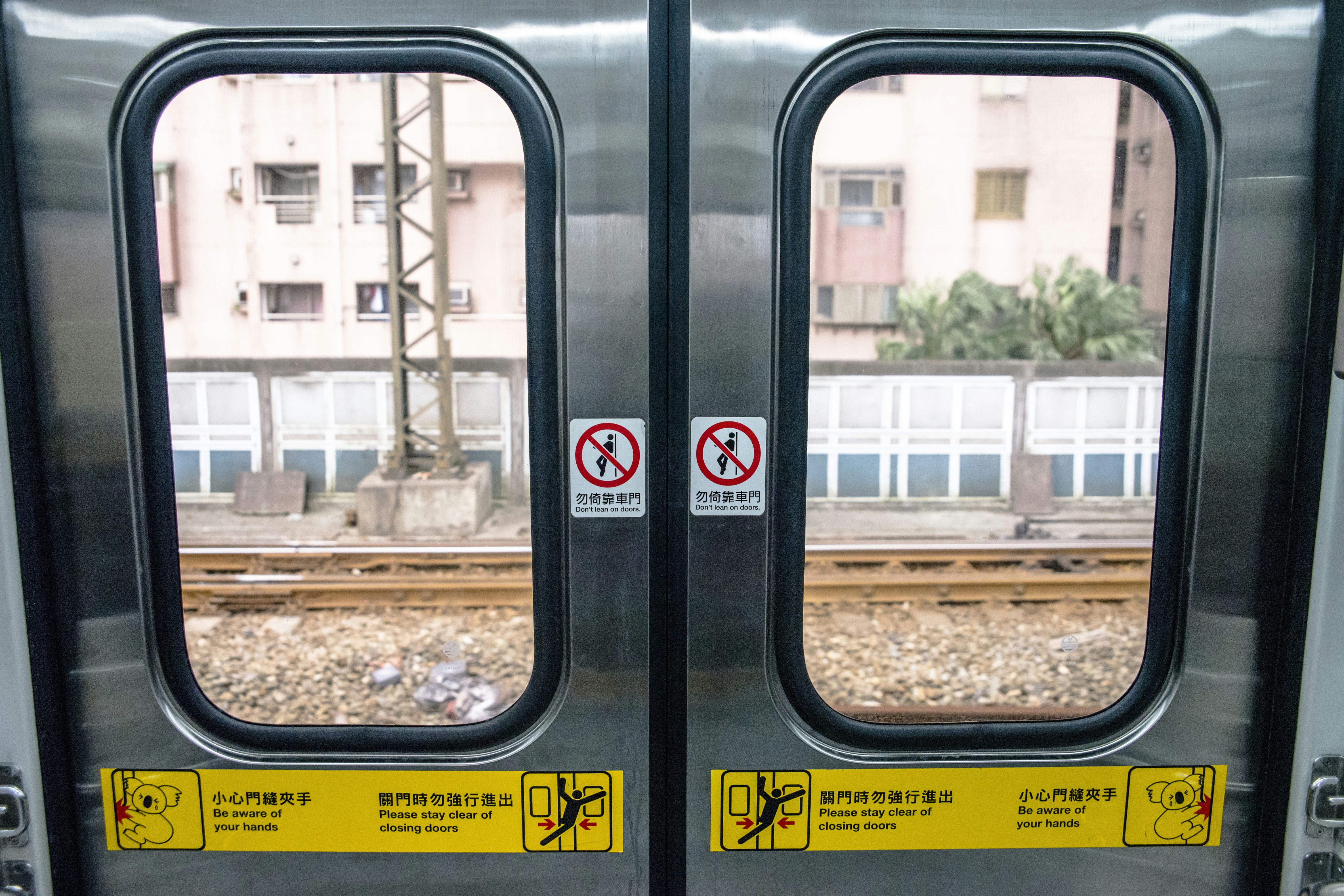 Train Doors Framed by Urban Rails