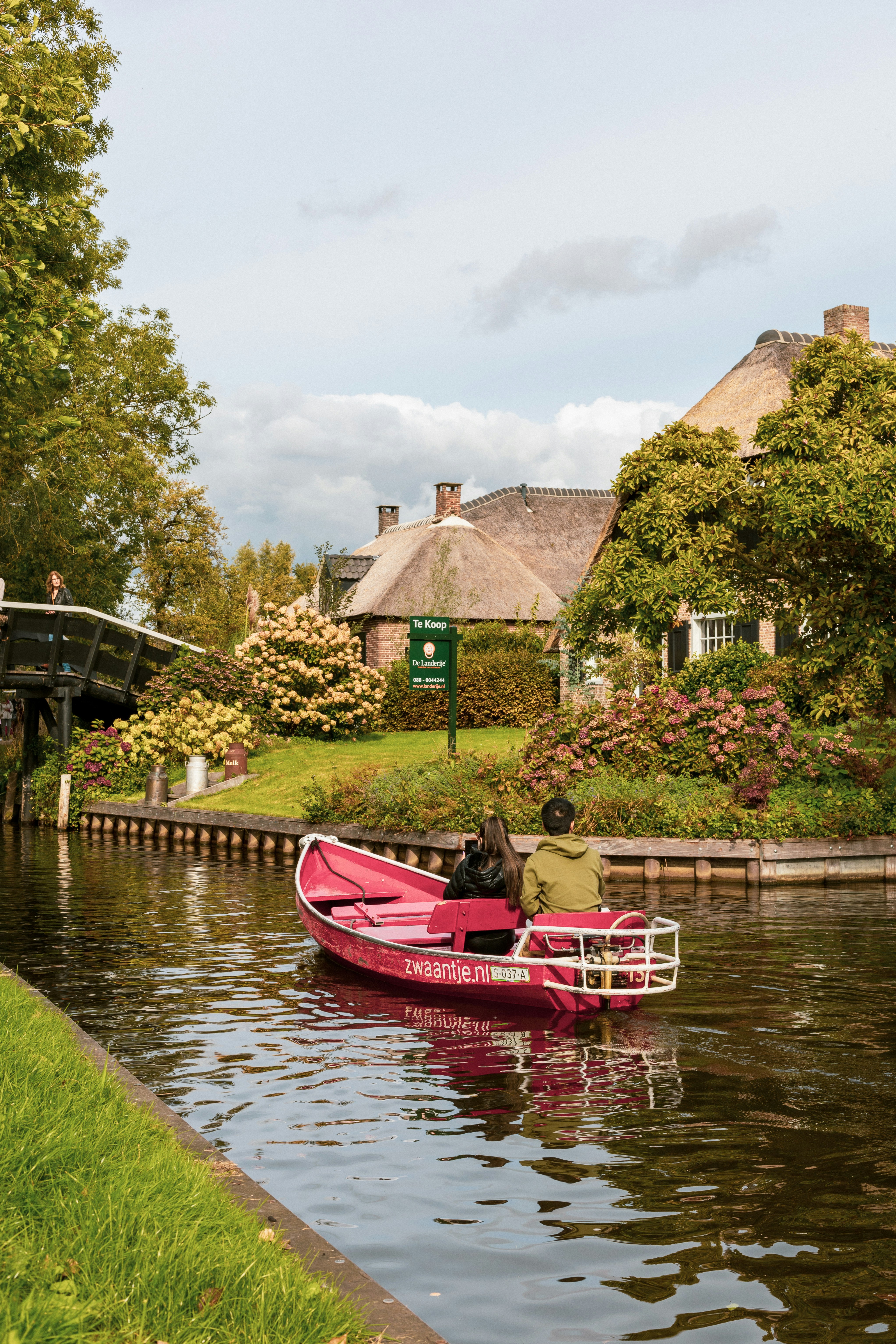 Pink-Boat Calm: A Quiet Canal Ride Through a Dutch-Style Village