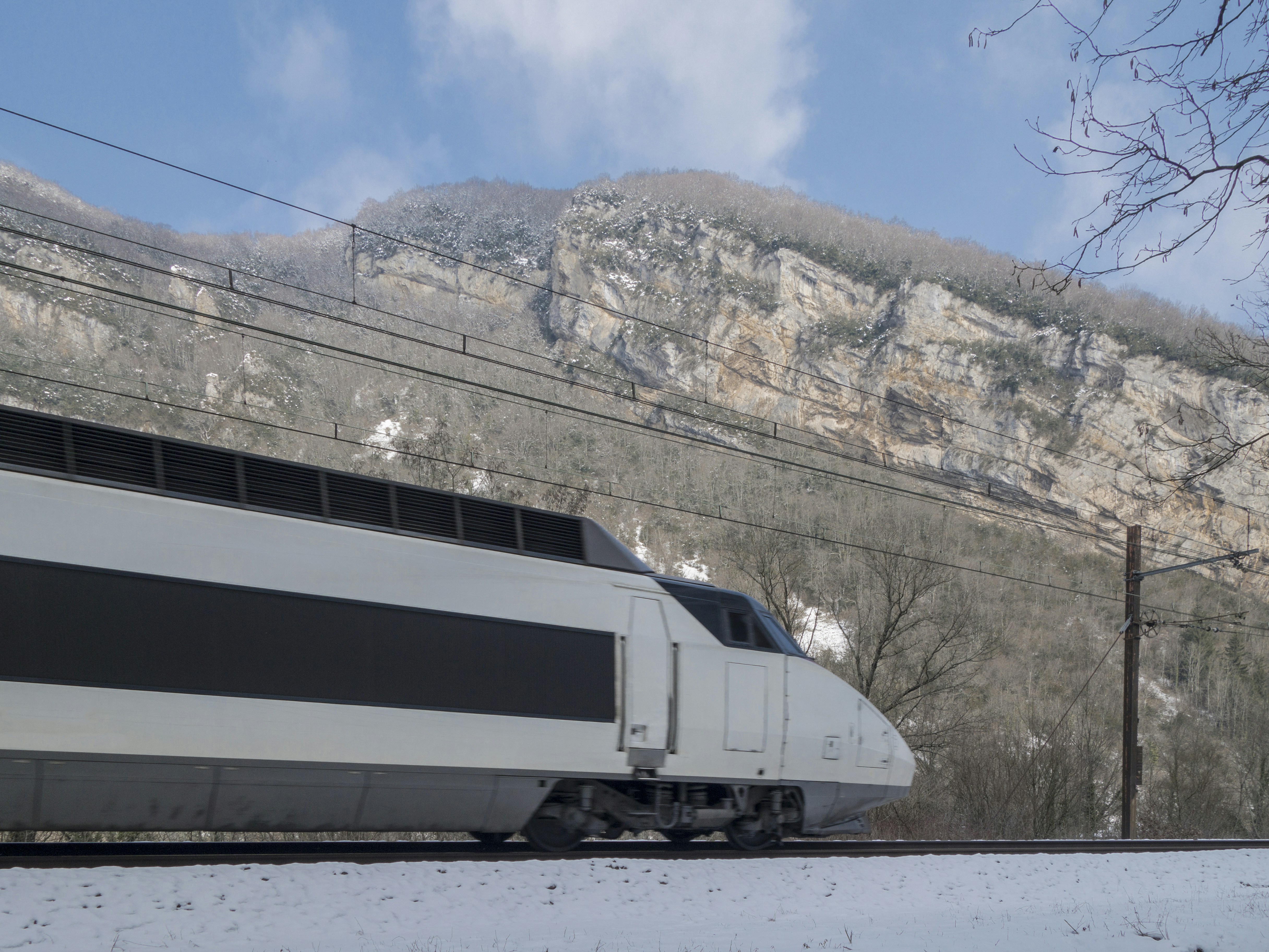 White Bullet on Snow: A modern train carving through frost-kissed mountains
