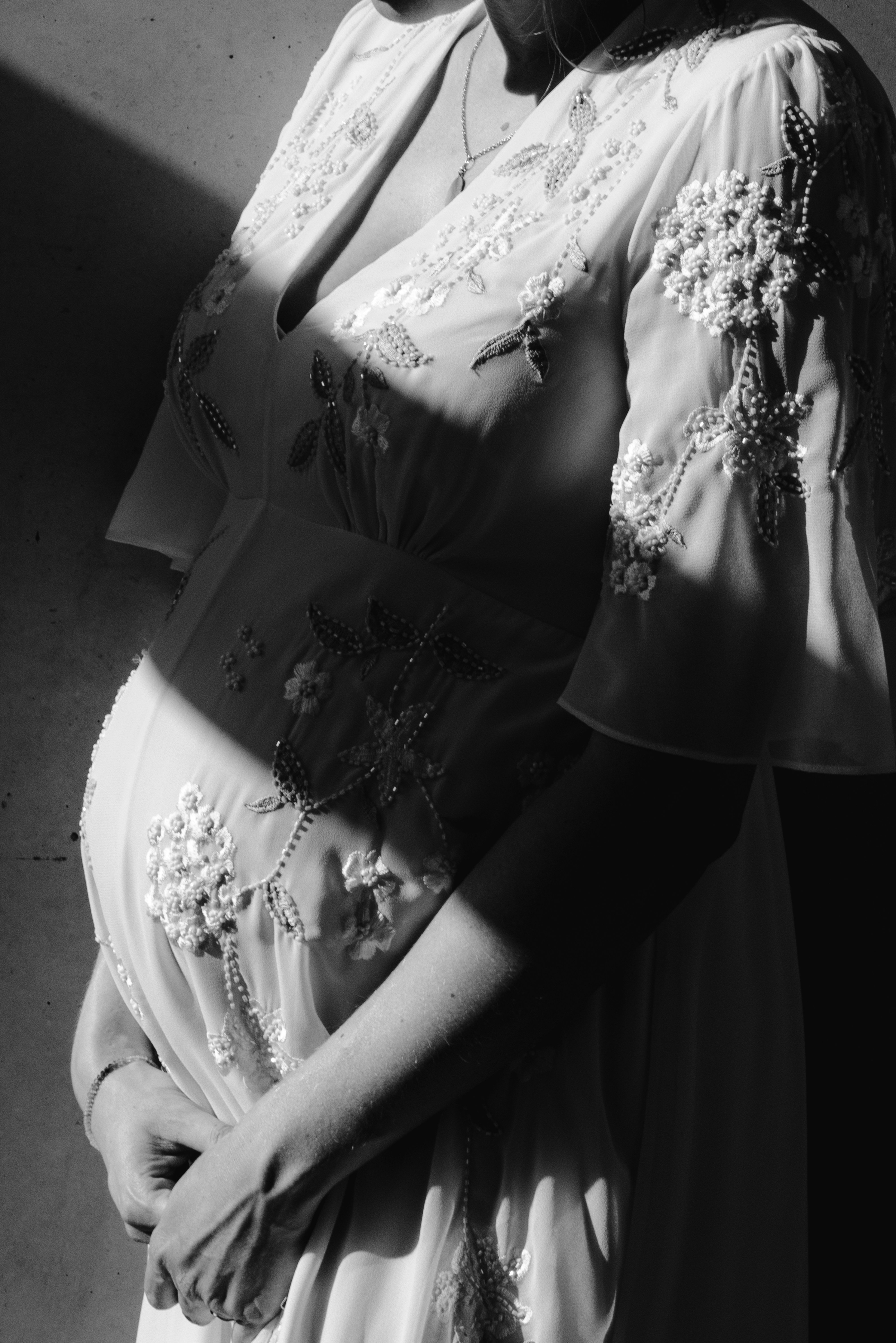 Graceful Expectation: A Pregnant Silhouette in Light and Shadow
