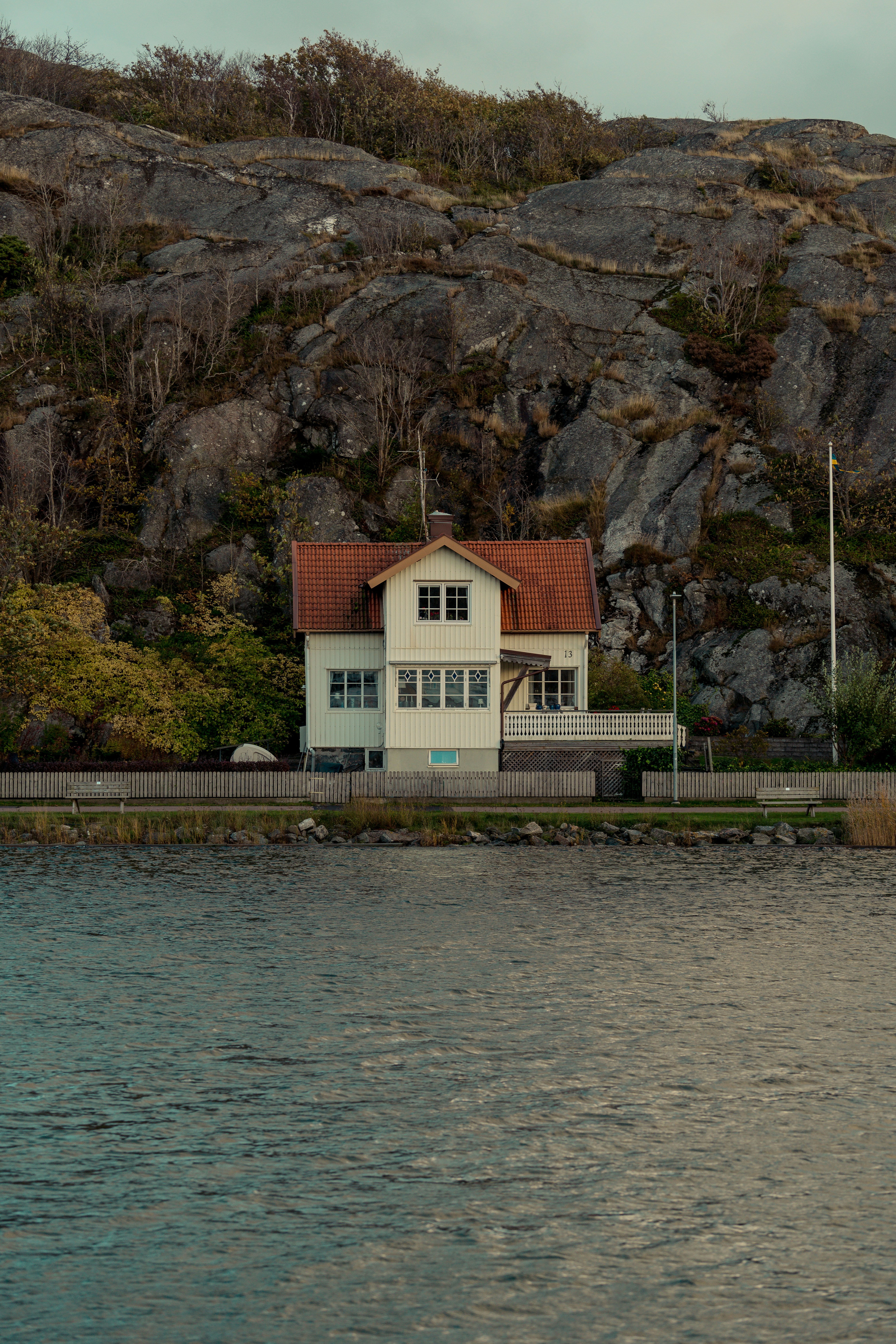 Lakeside Cottage at the Foot of a Granite Cliff