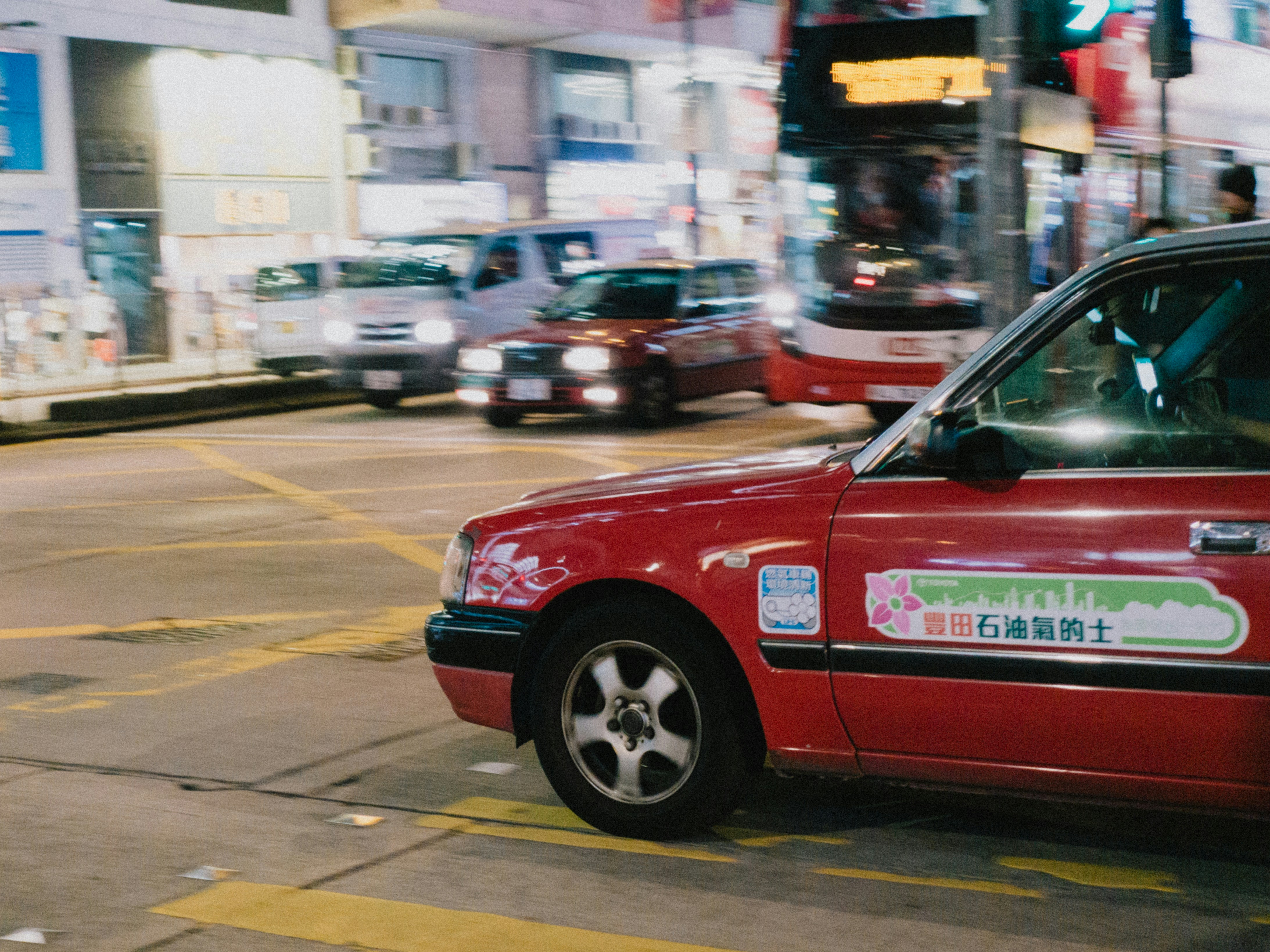 Neon Velocity: A Red Taxi Piercing Through a Neon City Street