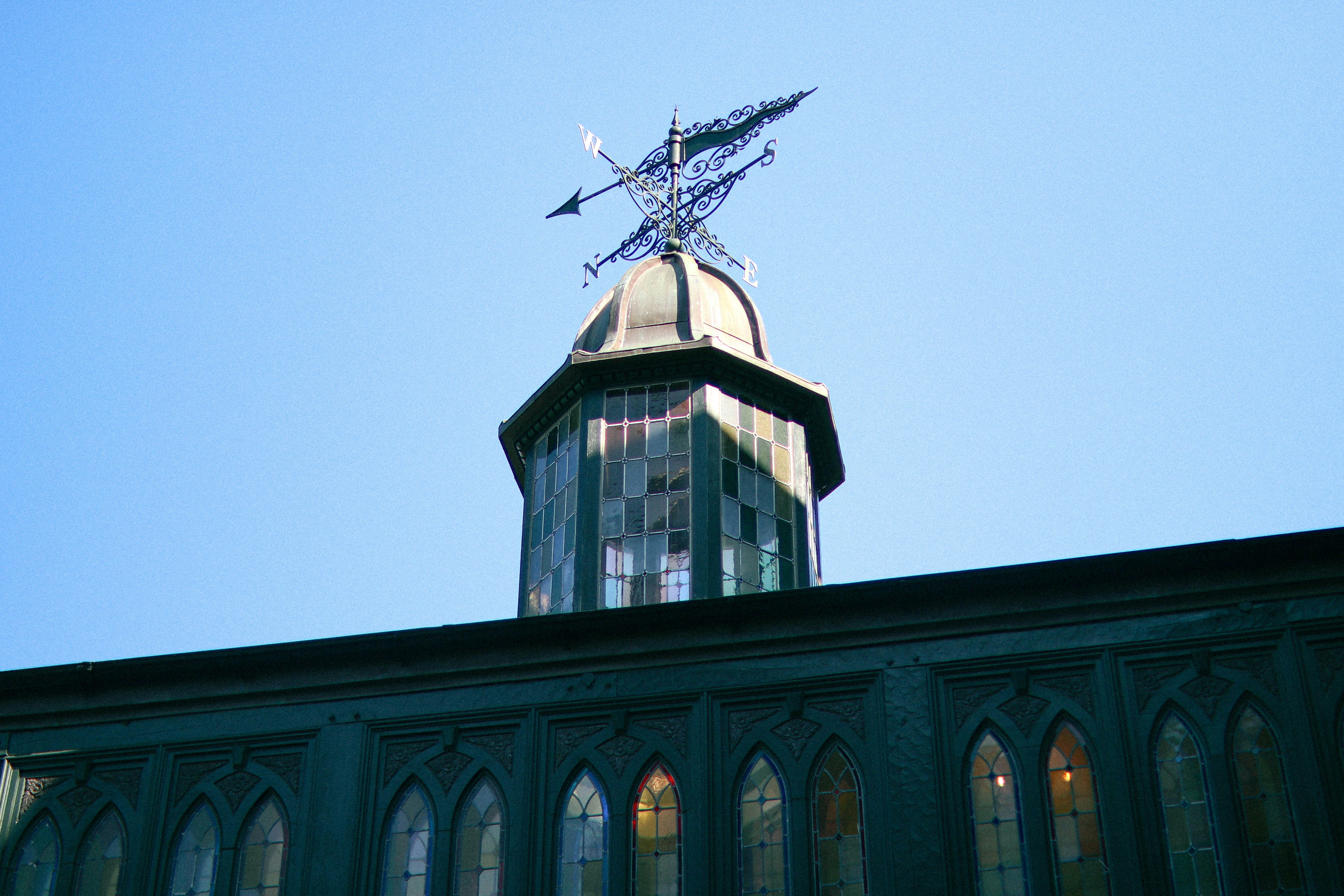 Cupola Silhouette: A Heritage Tower Rises Above Arched Facade