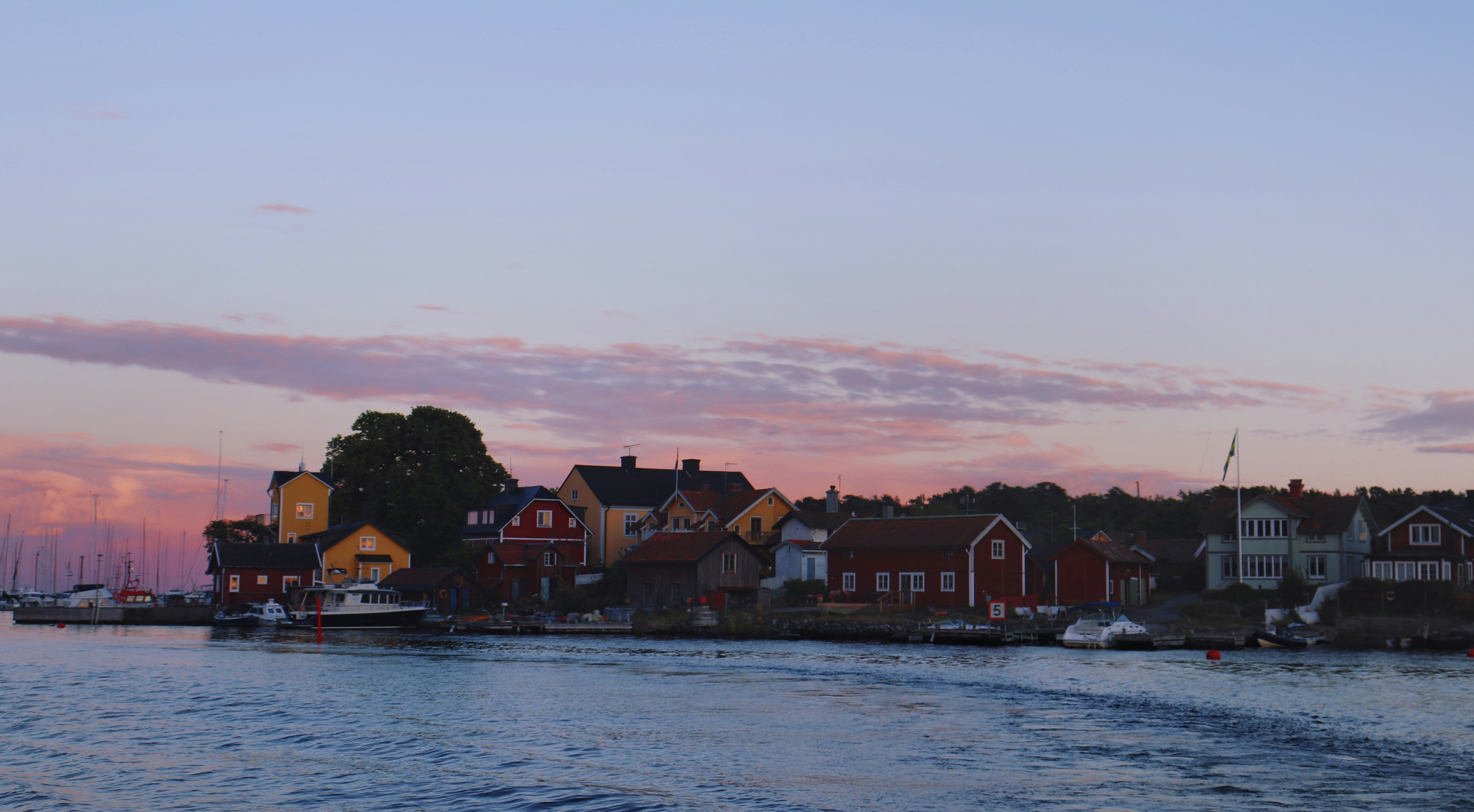 a group of houses next to a body of water