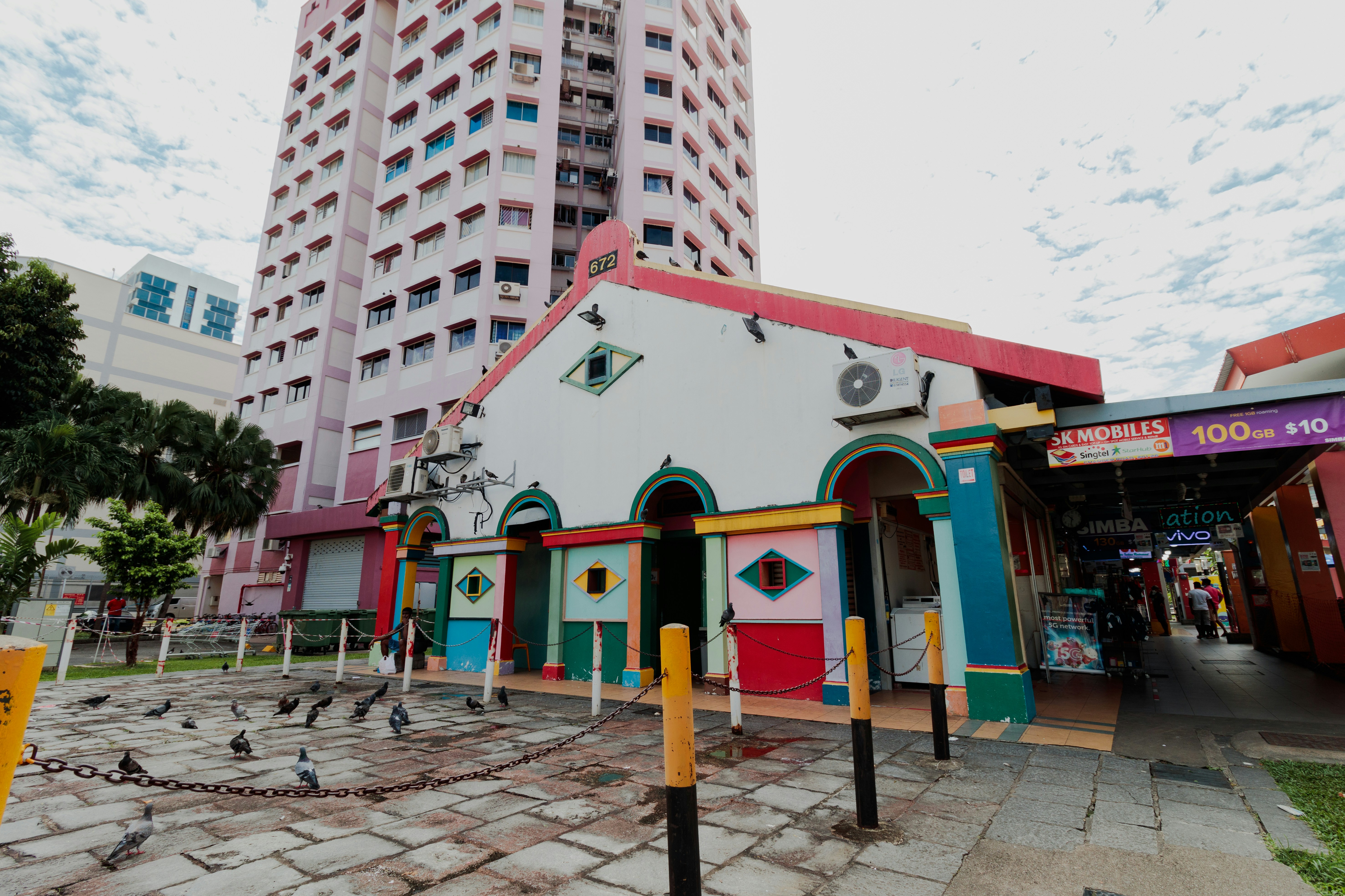Pastel Arches Before the Tower: A Colorful Street Facade