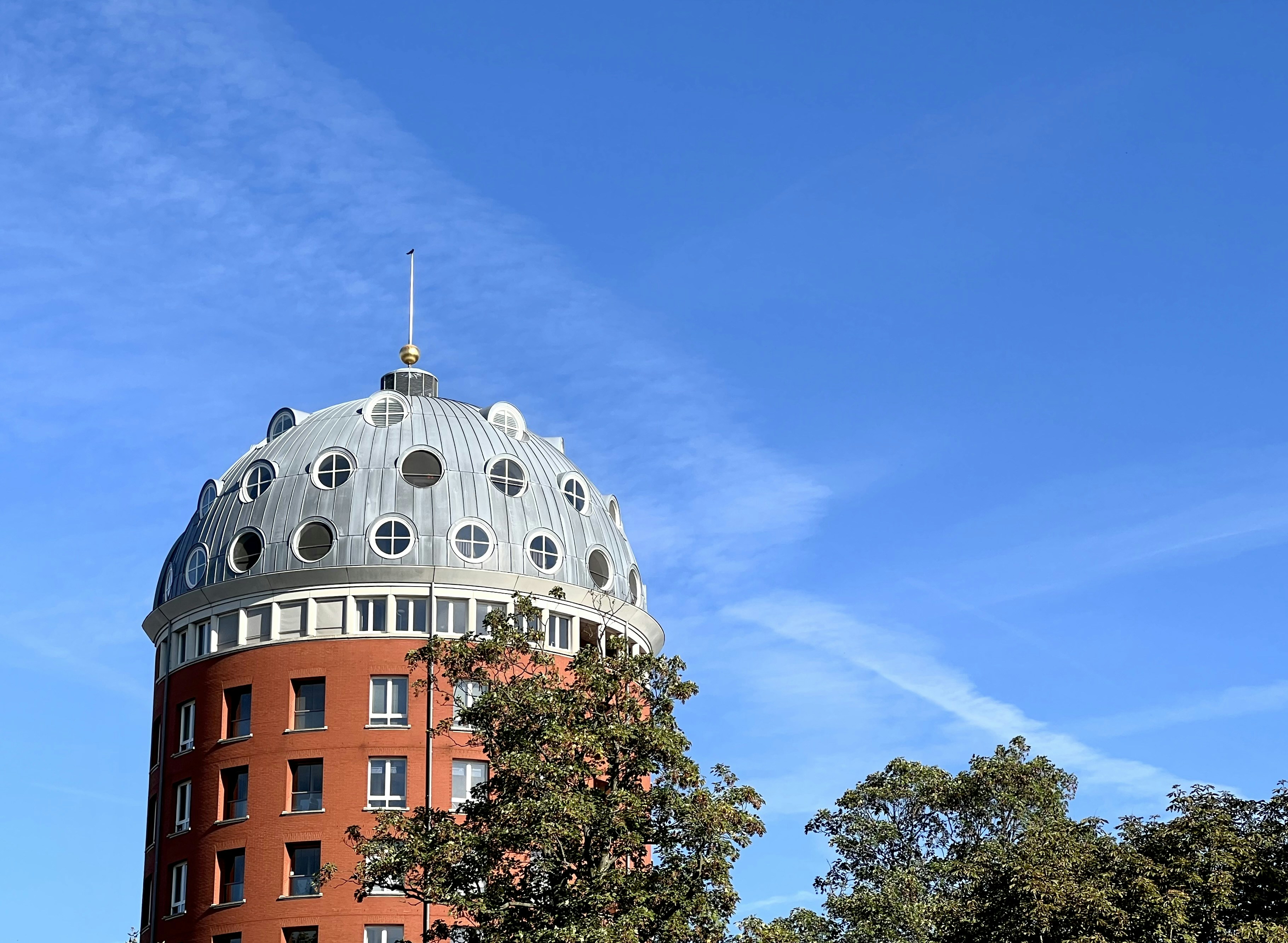 Dome-Top Brick Tower: A Red Facade Against a Clear Azure Sky