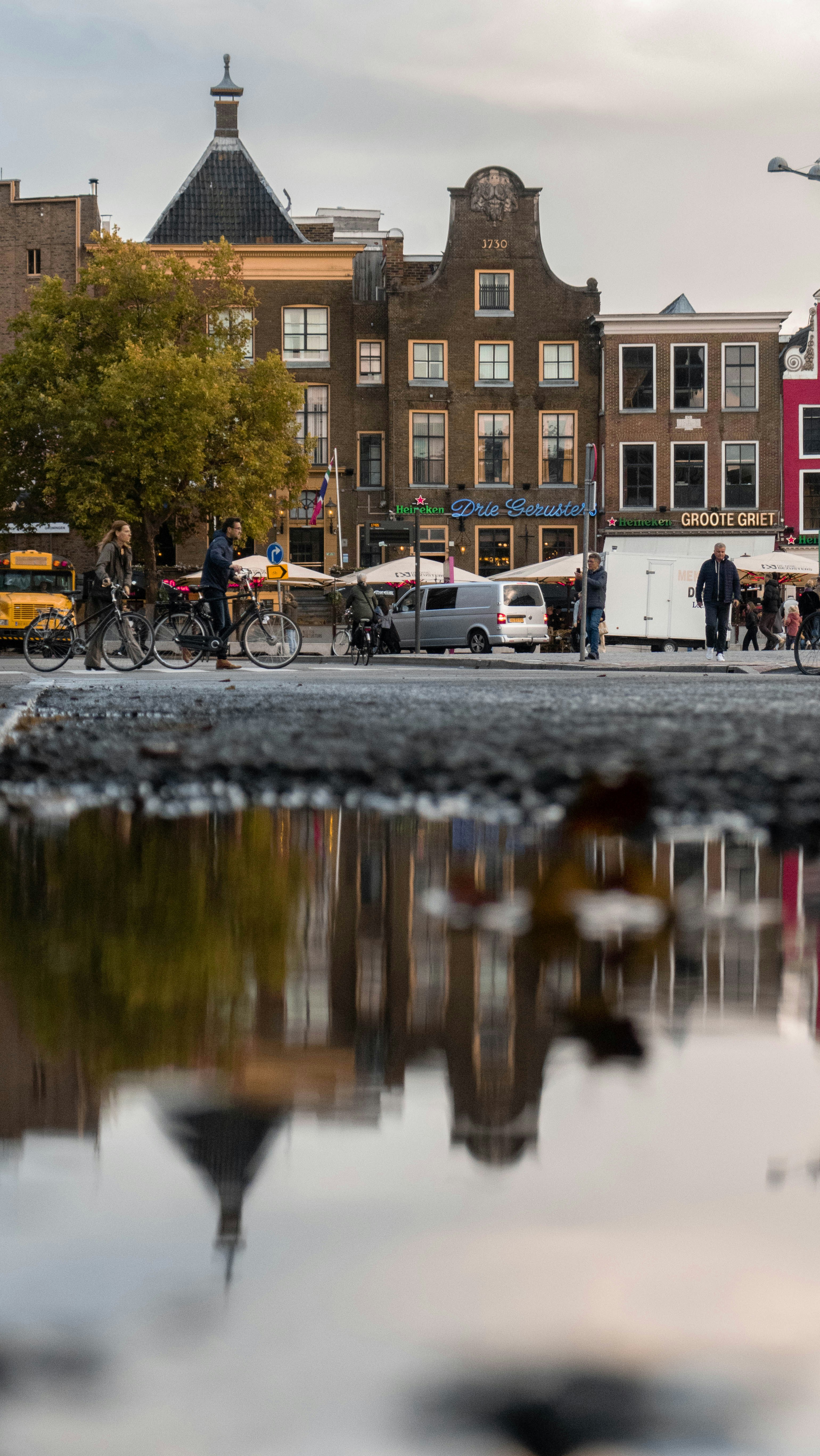 City Street Reflections: Pedestrians, Bicycles, and Historic Facades