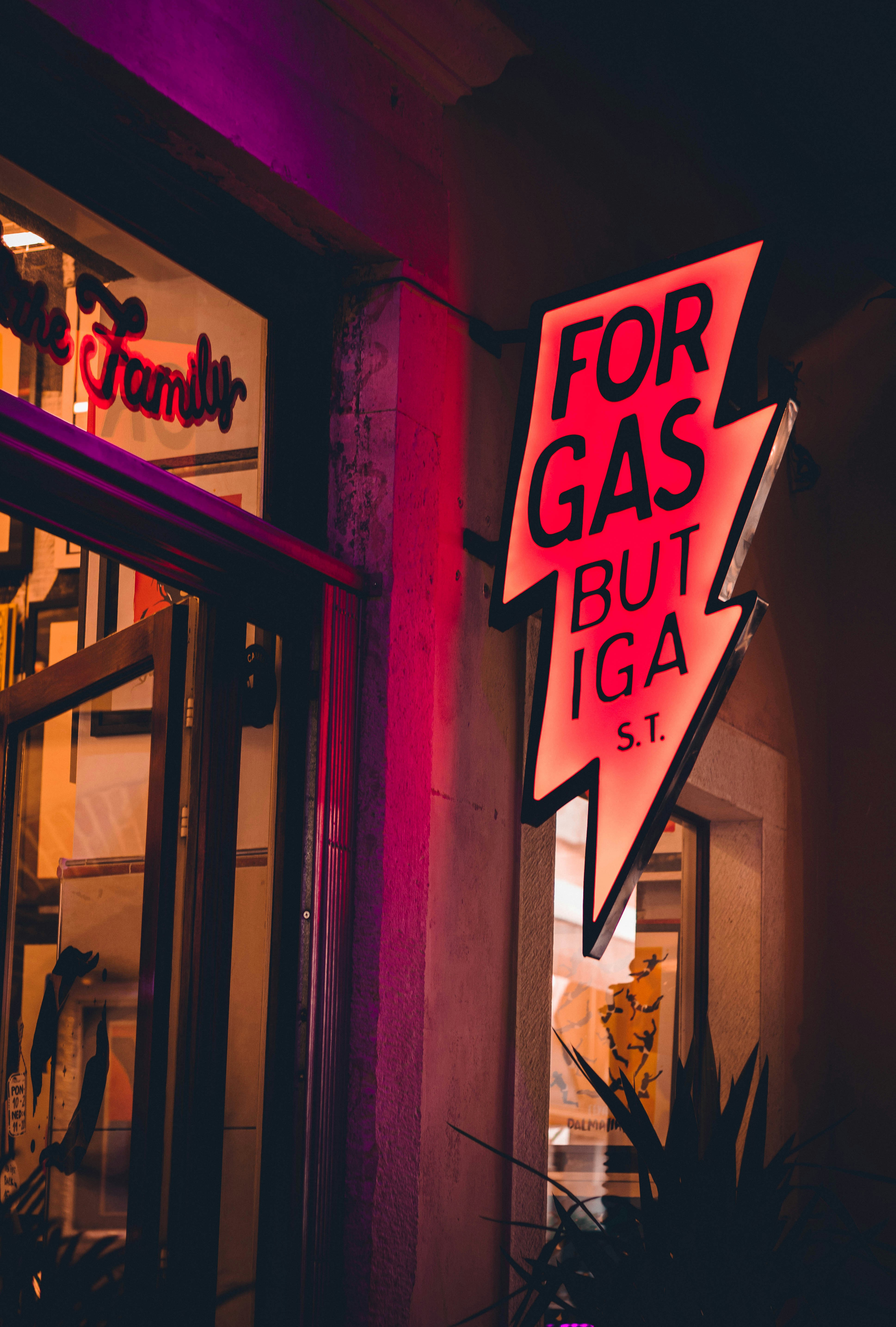 Neon Sign Streaks: A Nighttime Window to a Cozy Shop