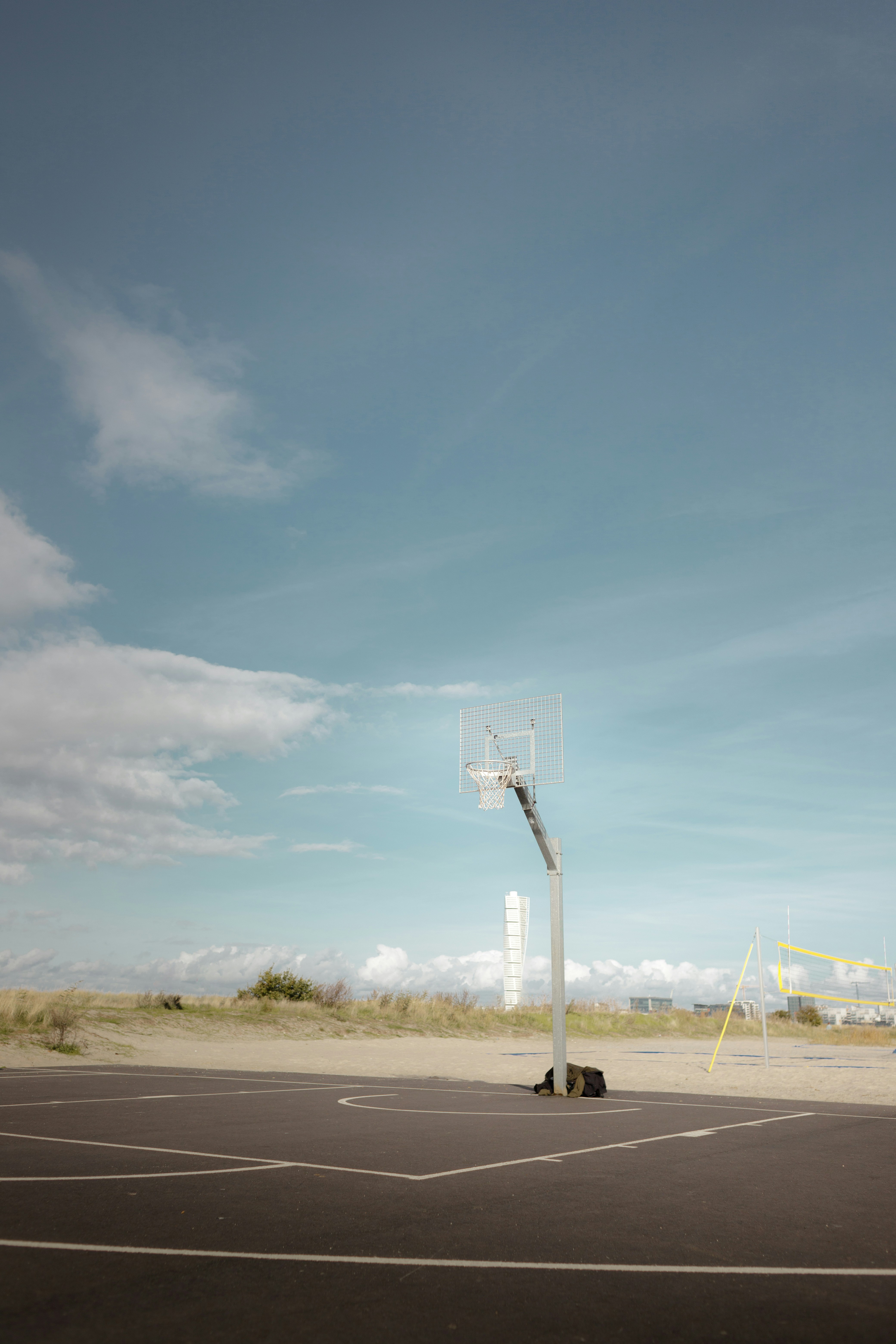 Basketball Hoop Quietly Reaches for the Wide Sky
