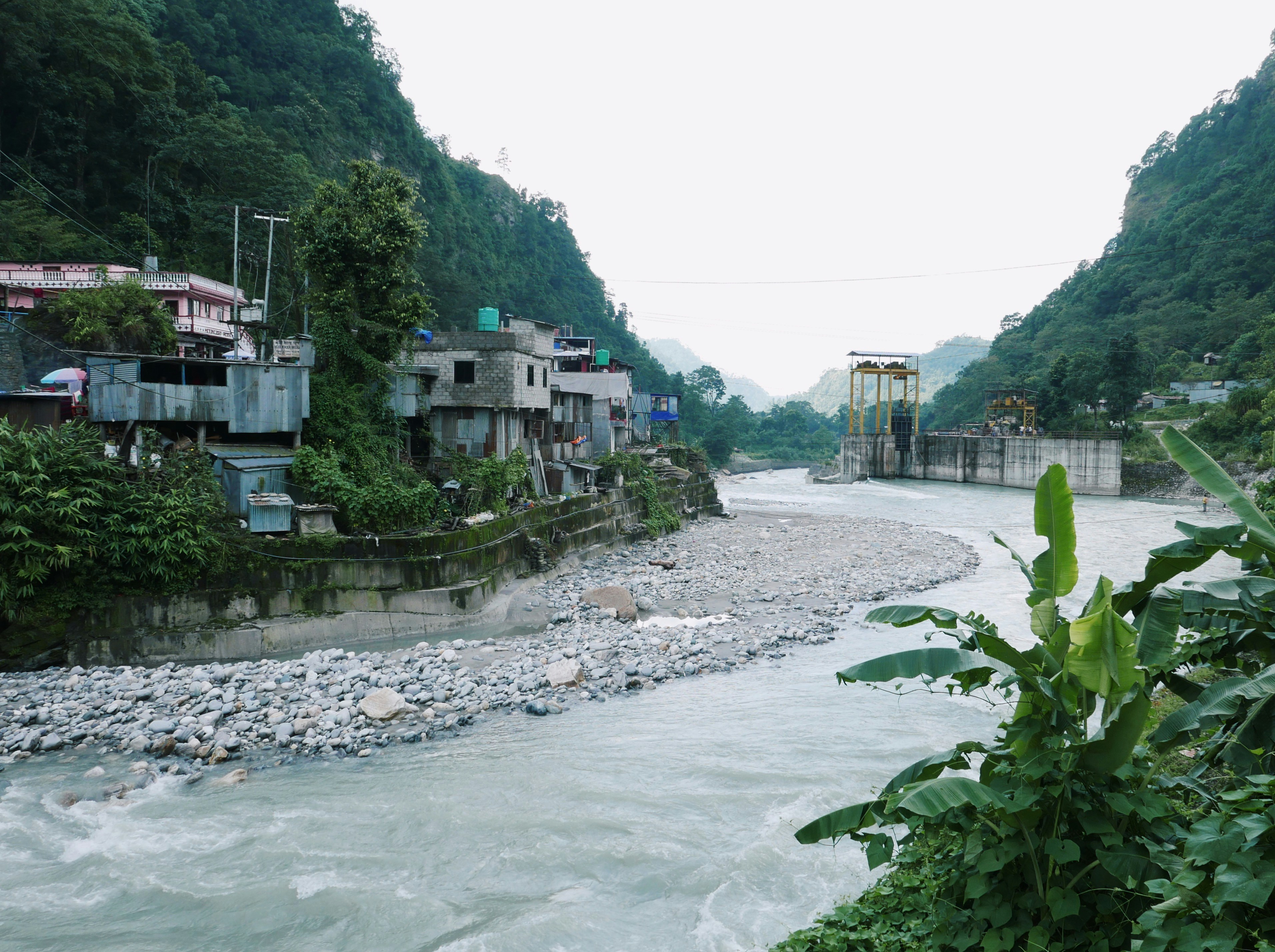 Riverside Hamlet: Verdant Gorge and a Distant Gate