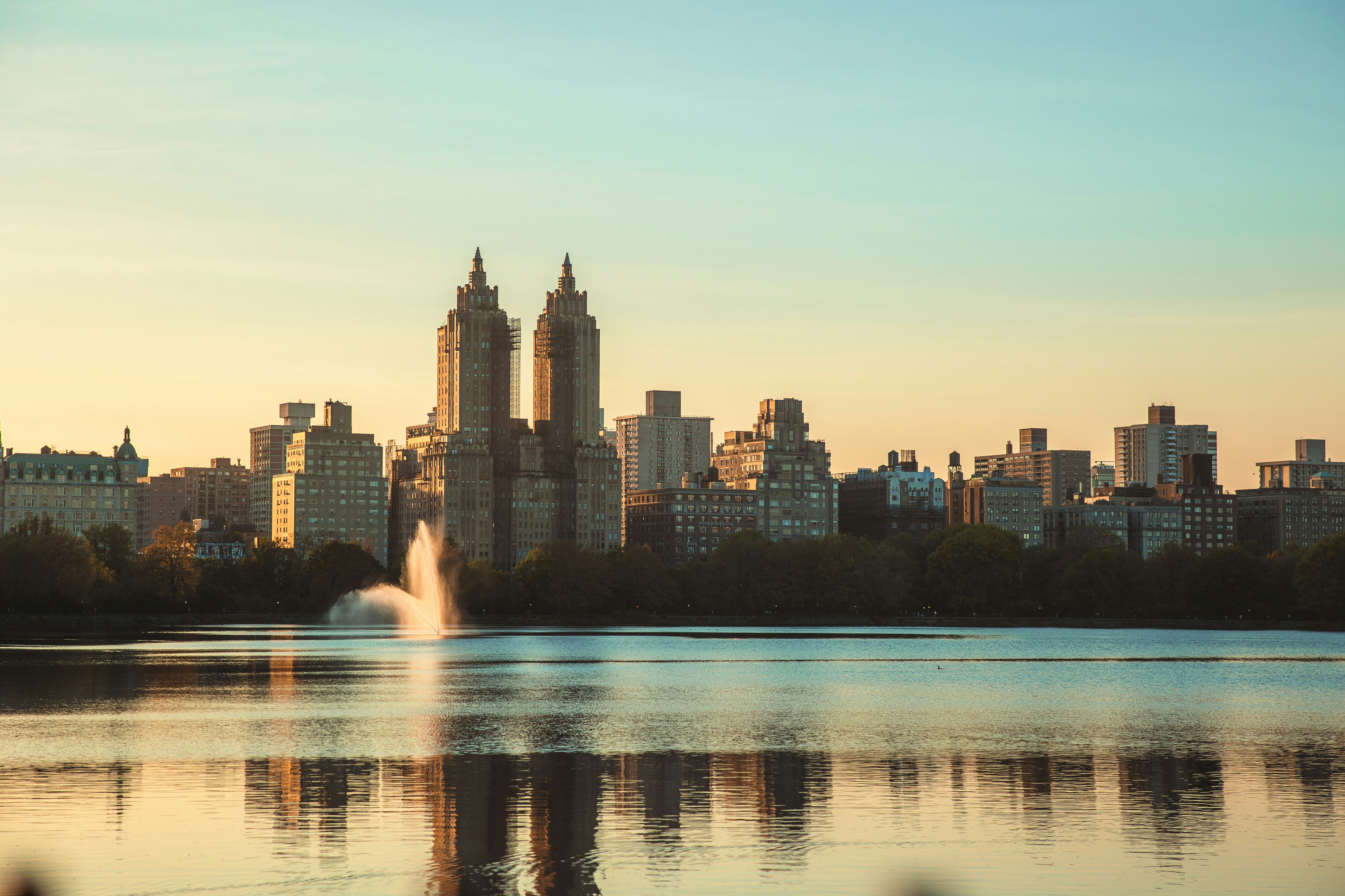 Dusk Towers: Golden Hour Reflections on a Tranquil Lake