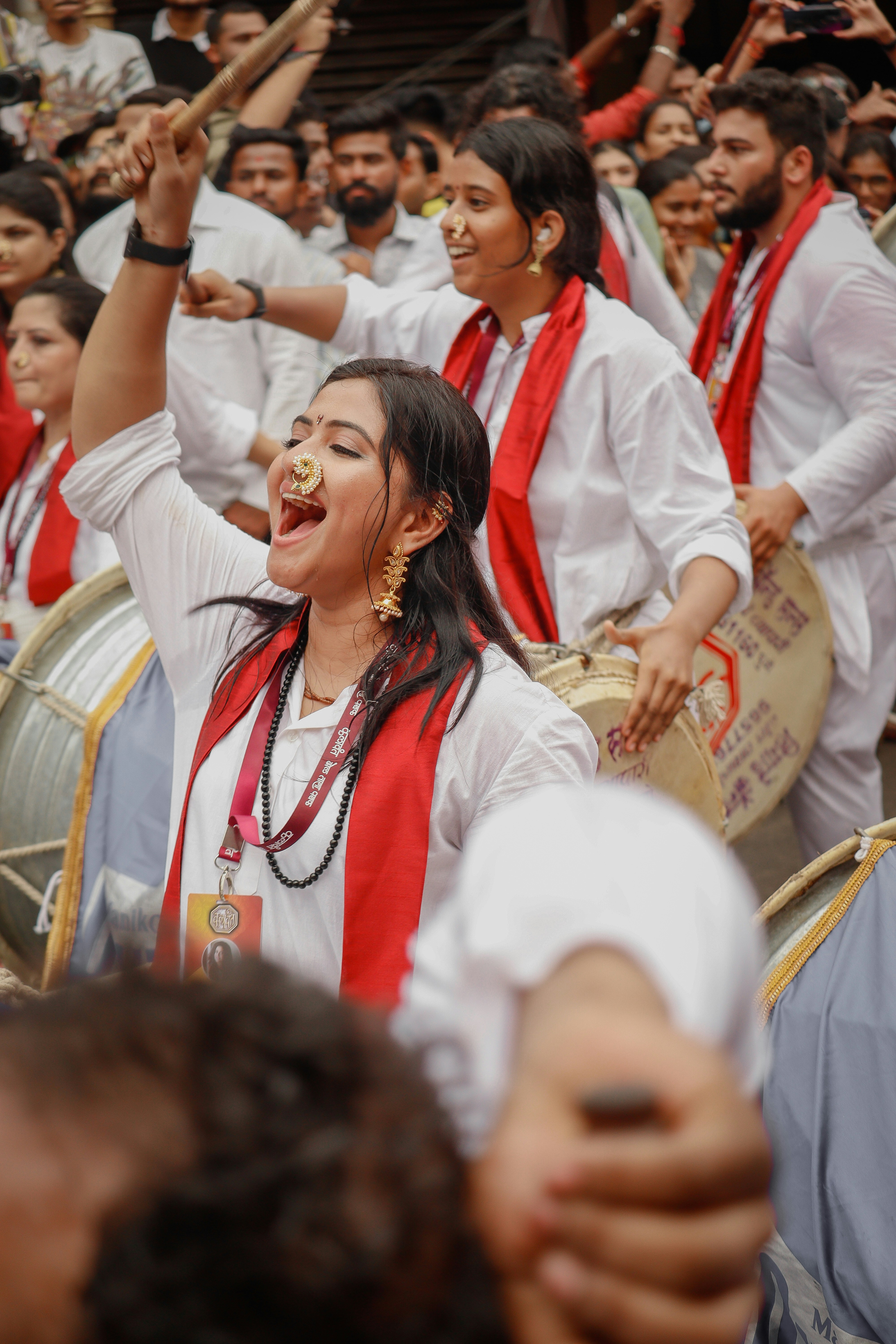 Rhythms in White: A front-row vocalist leads a street drum procession