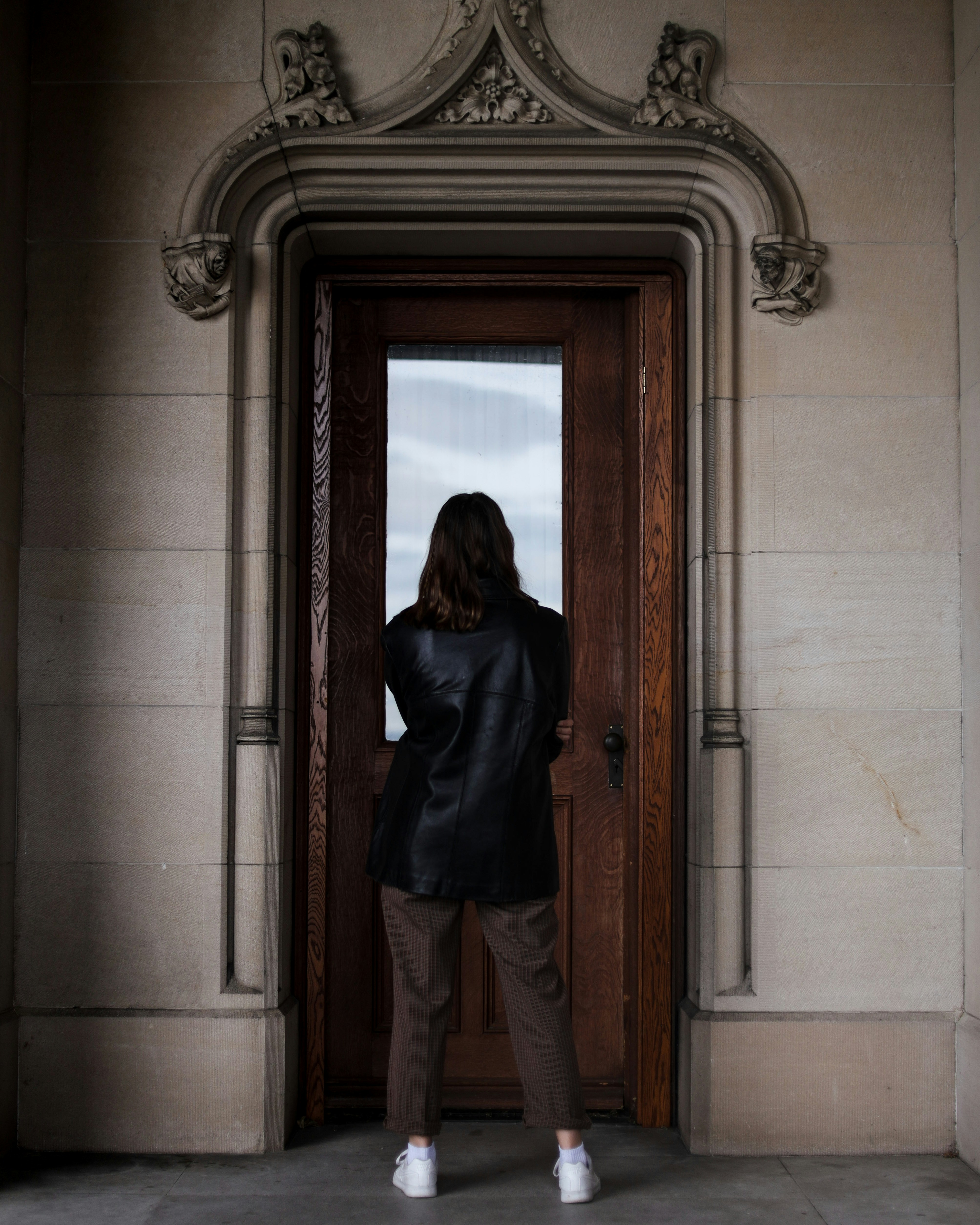 A man standing in front of a door photo – Free Looking out of the ...