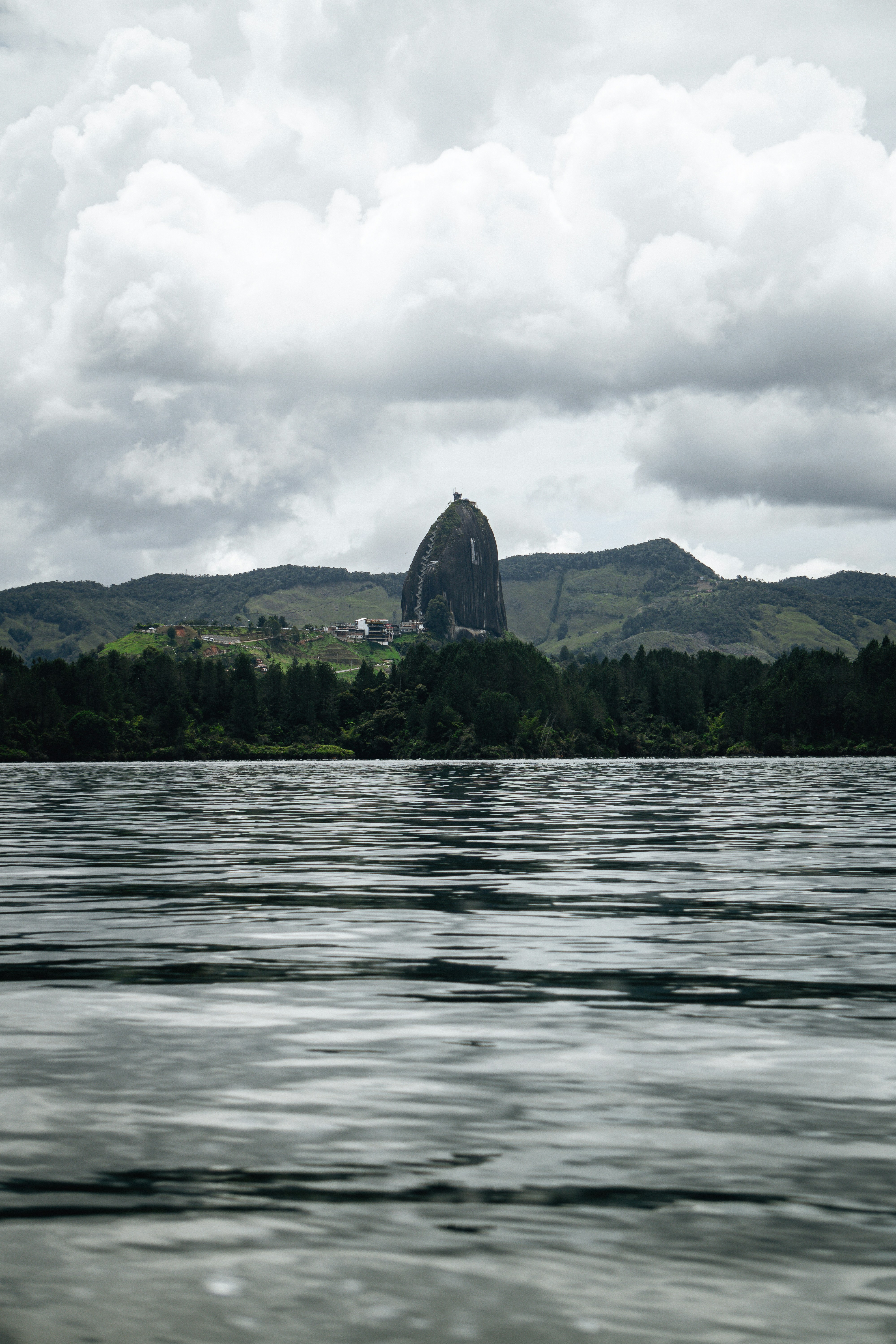 Silhouette of a solitary tower rising over a tranquil lakeshore