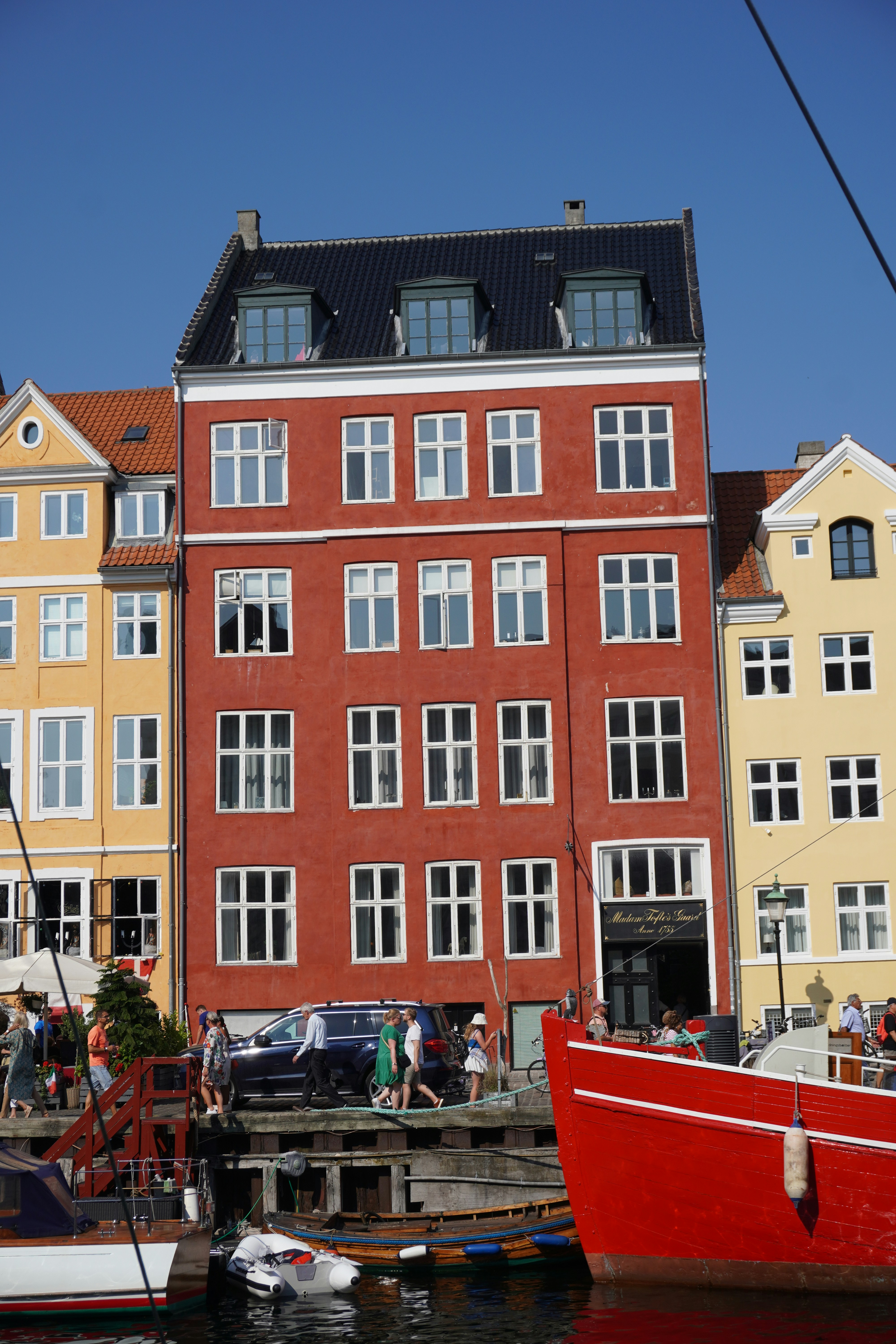 Red Brick Row at Nyhavn: A Sunlit Canalfront Between Pastels and Boats