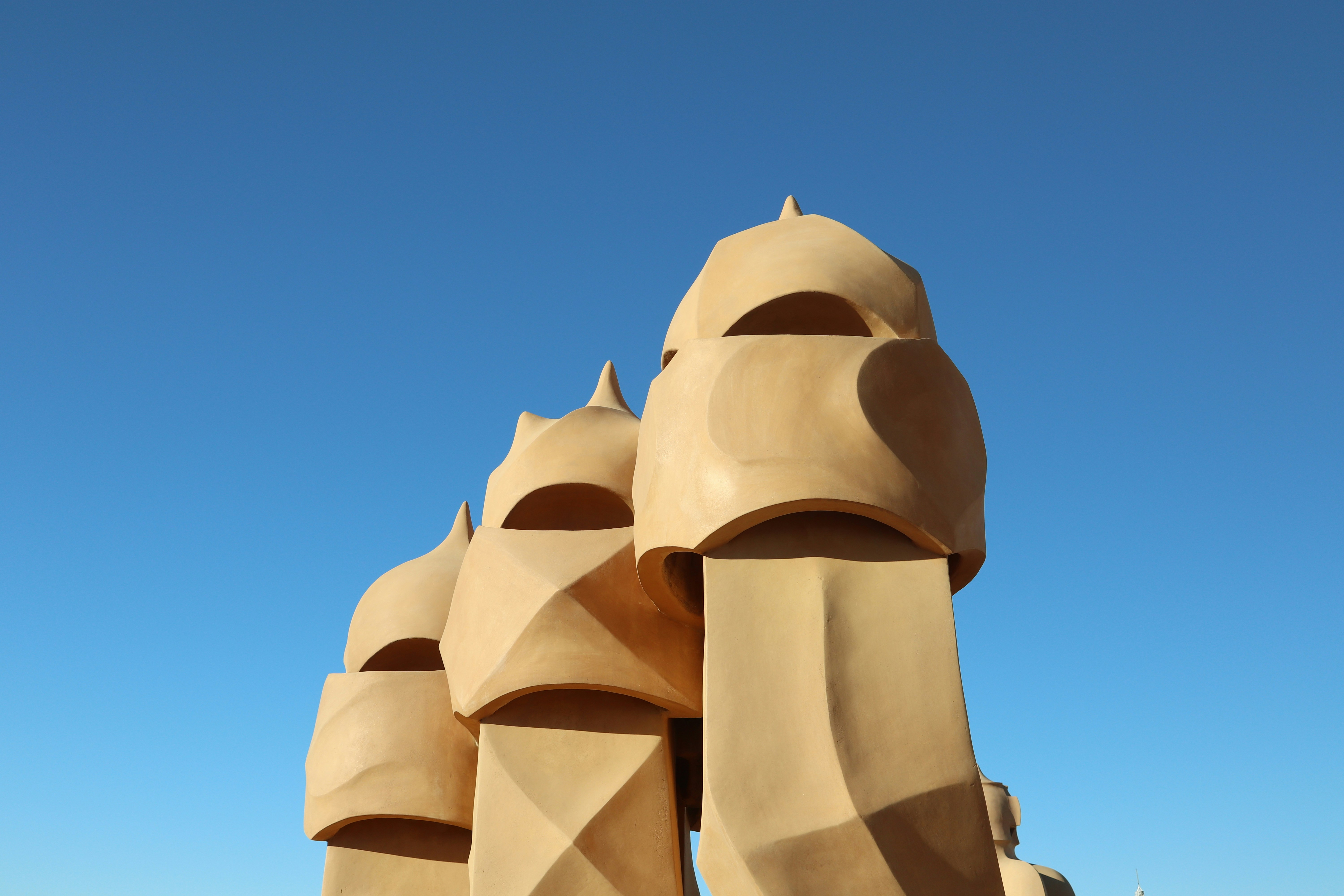 Gaudí's Park Güell Chimneys Reaching Toward a Clear Blue Sky