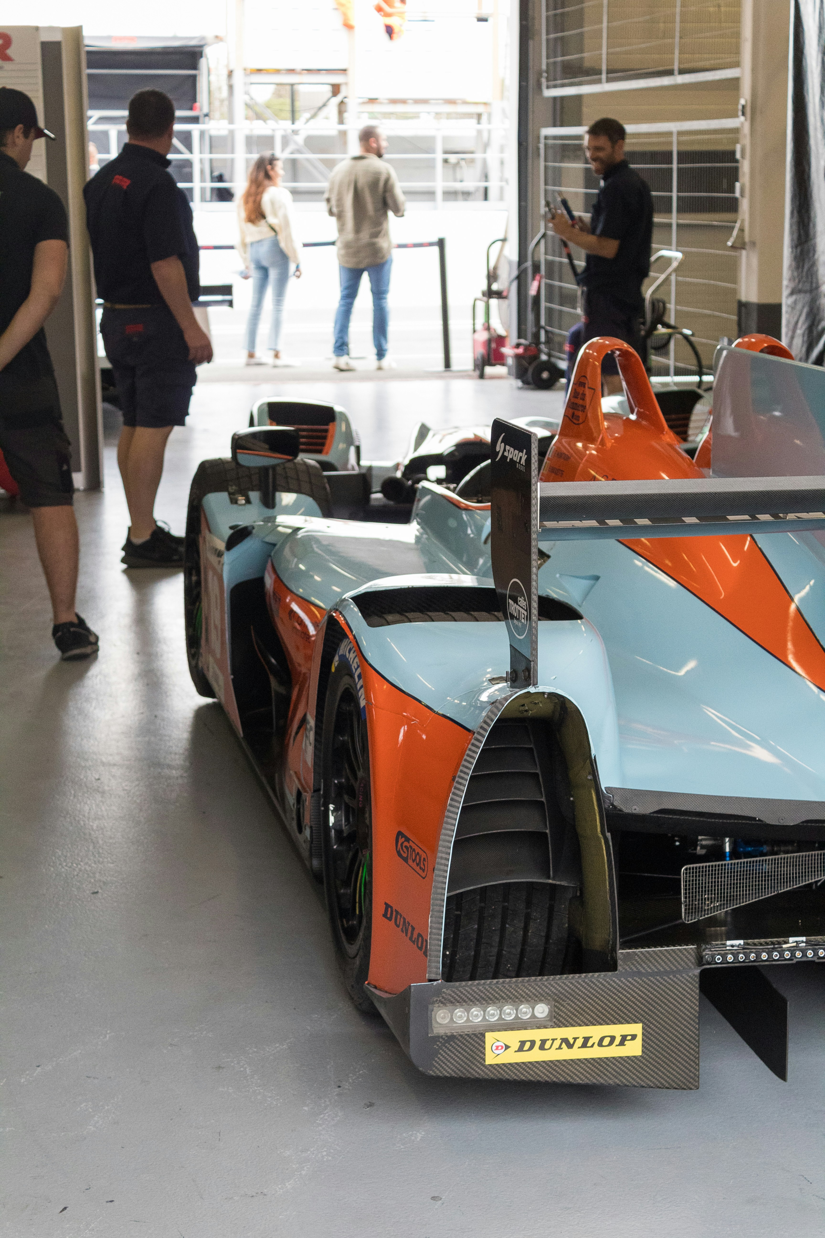 Racecar in the Pit: Neon Blue and Orange Precision
