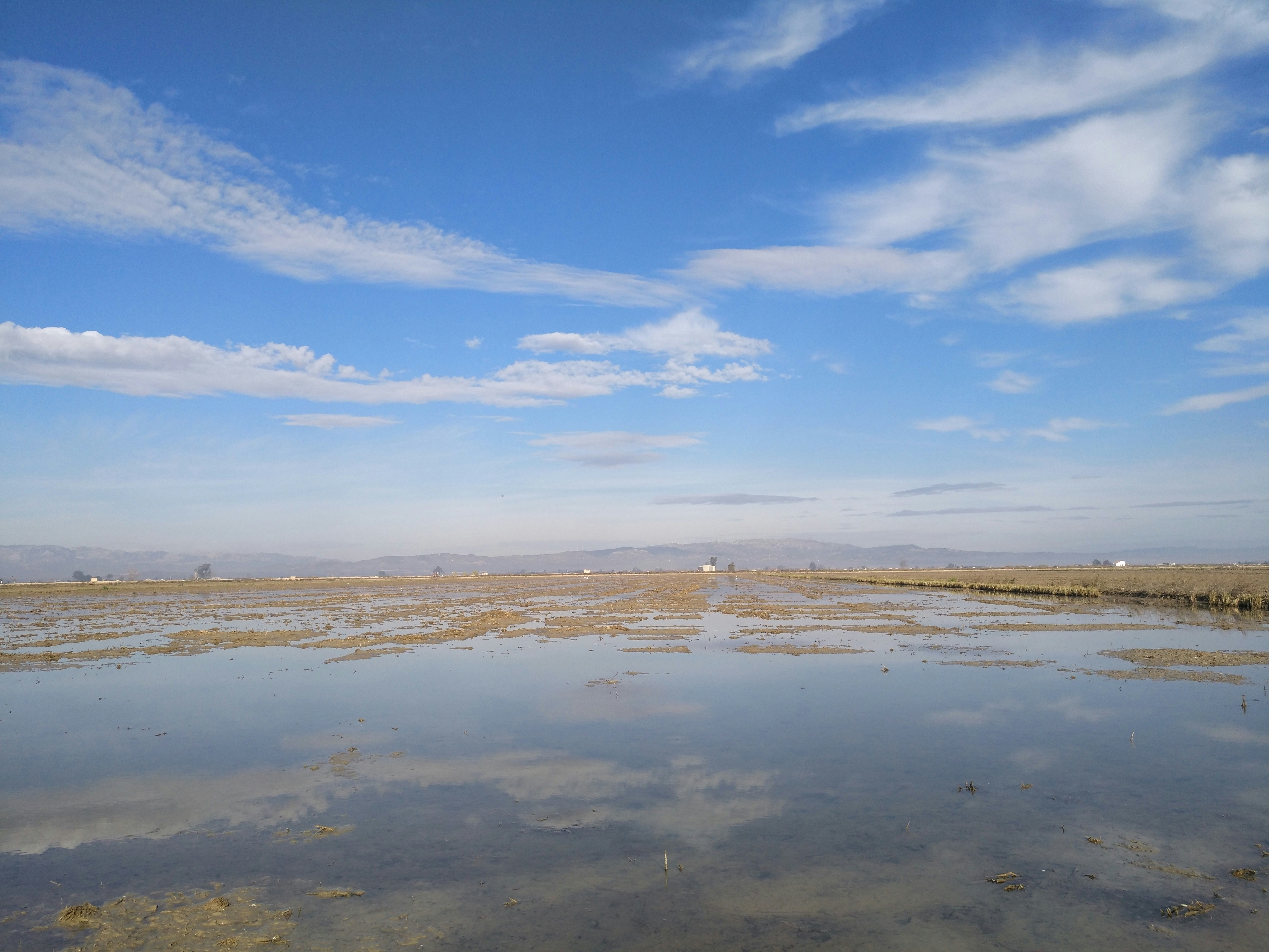 A large flat area with a body of water in it photo – Free Sky Image on ...