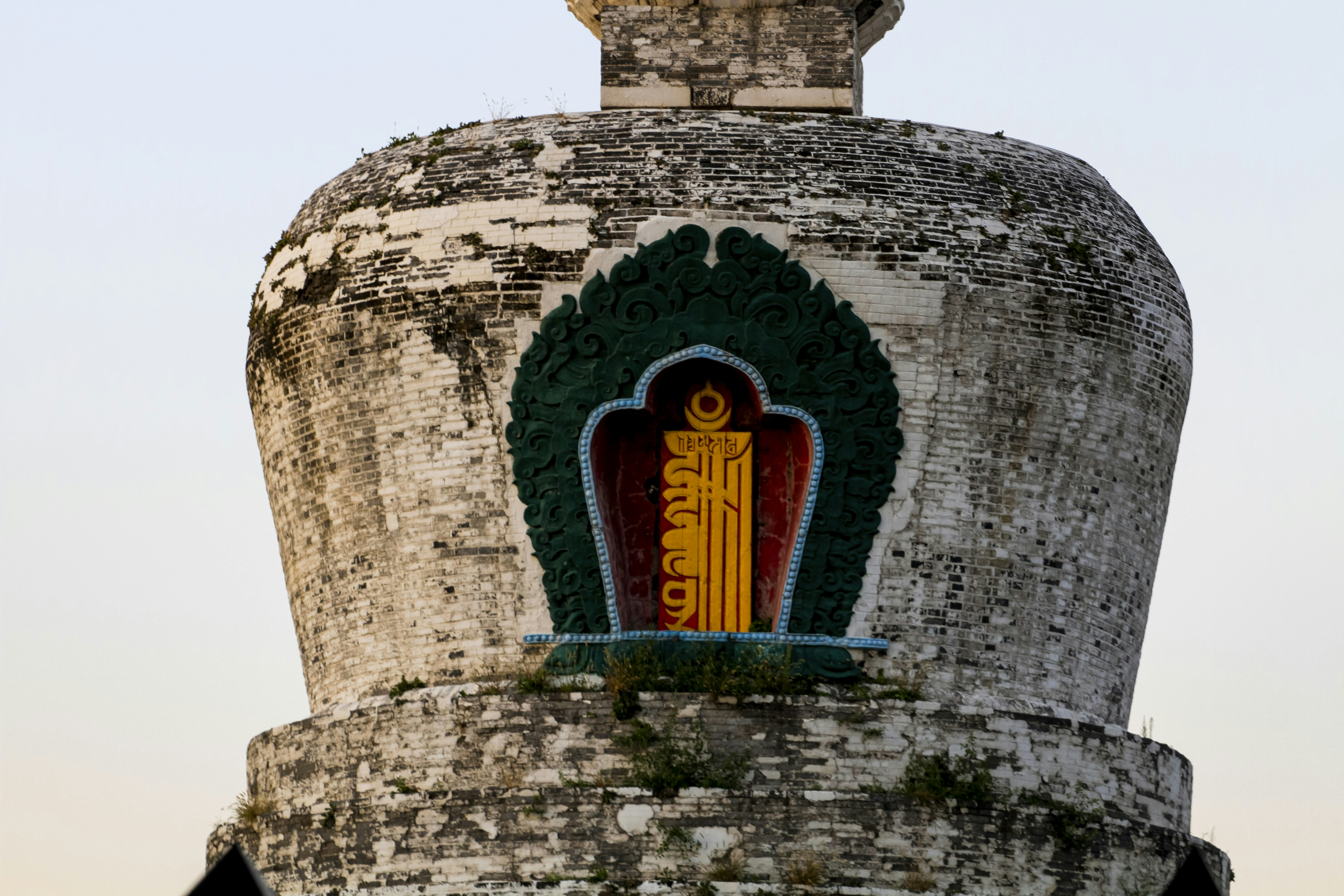 Gilded Buddha in a Timeworn Brick Turret
