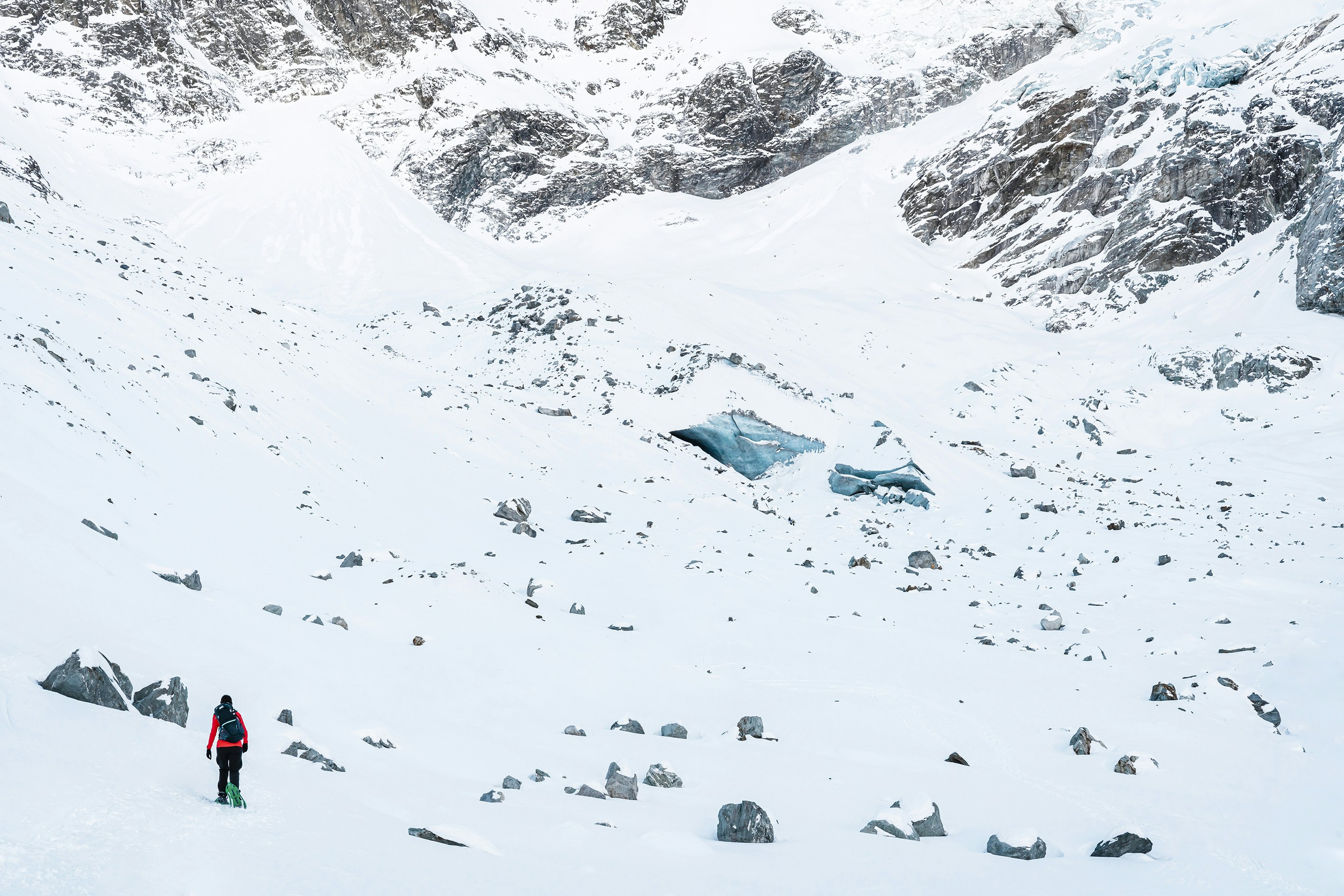 Alpine Solitude: A lone climber in a sea of white