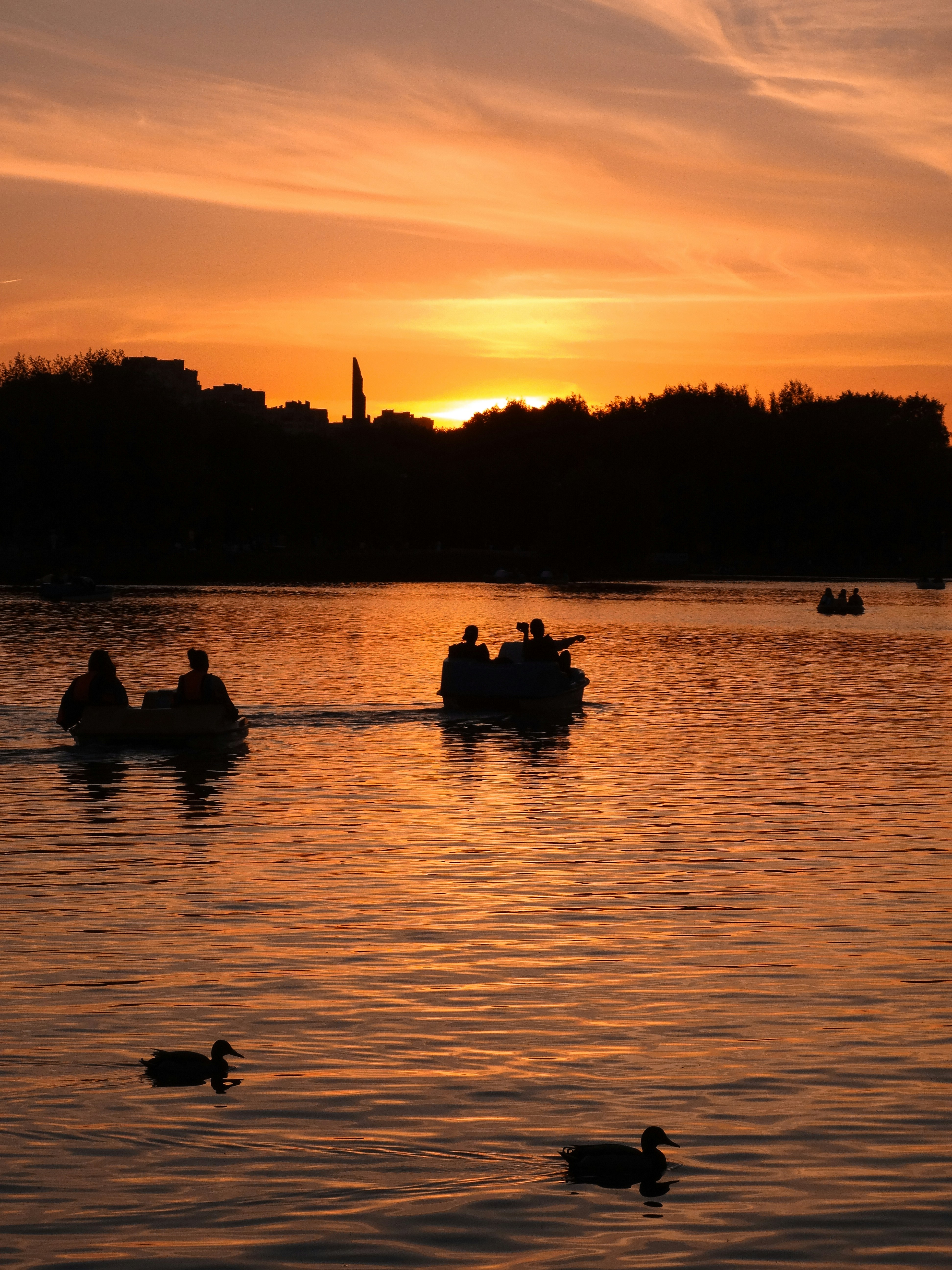 Golden Hour Silhouettes: Boats and a Quiet Lake at Sunset
