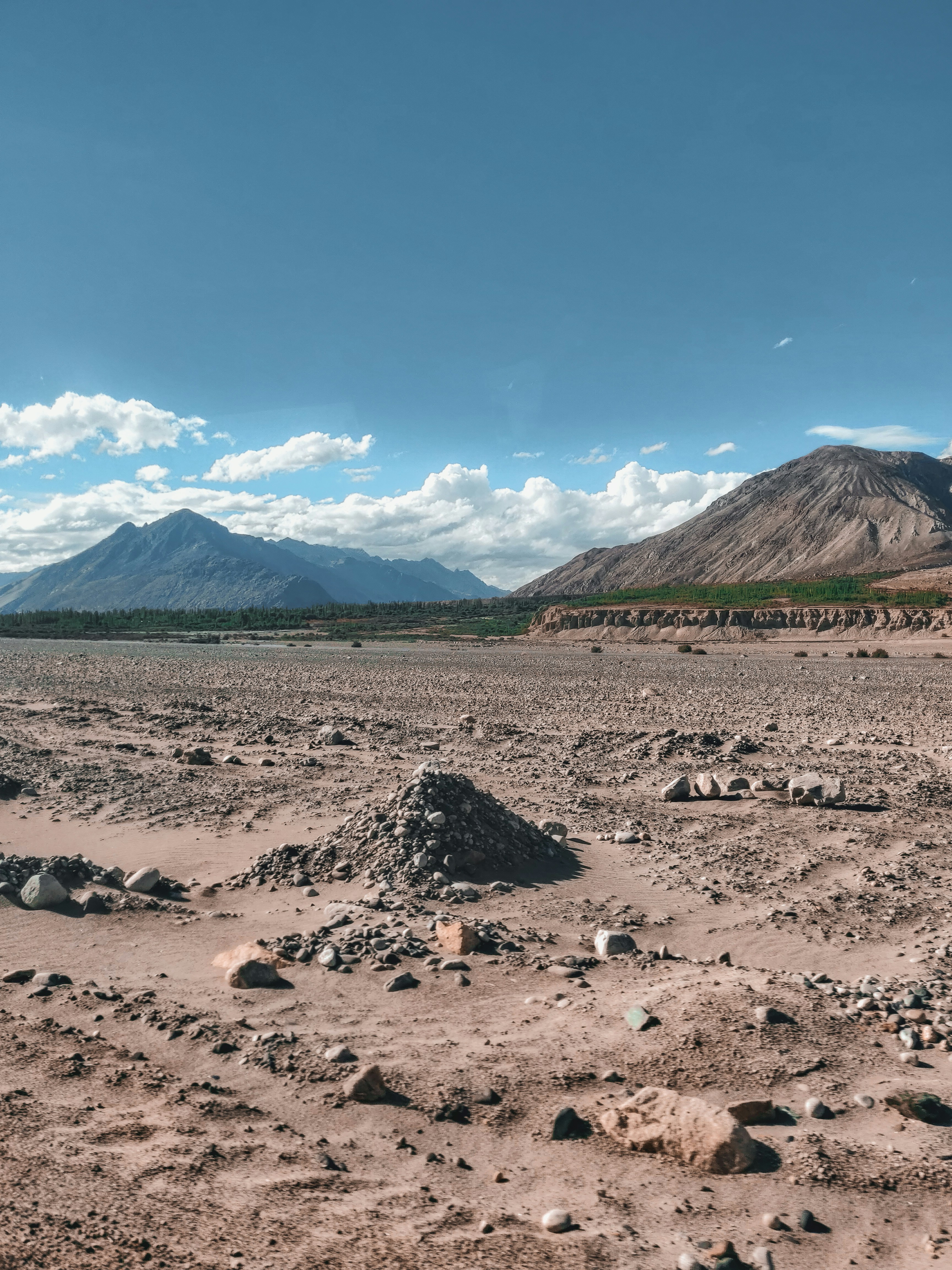 a rocky area with mountains in the background
