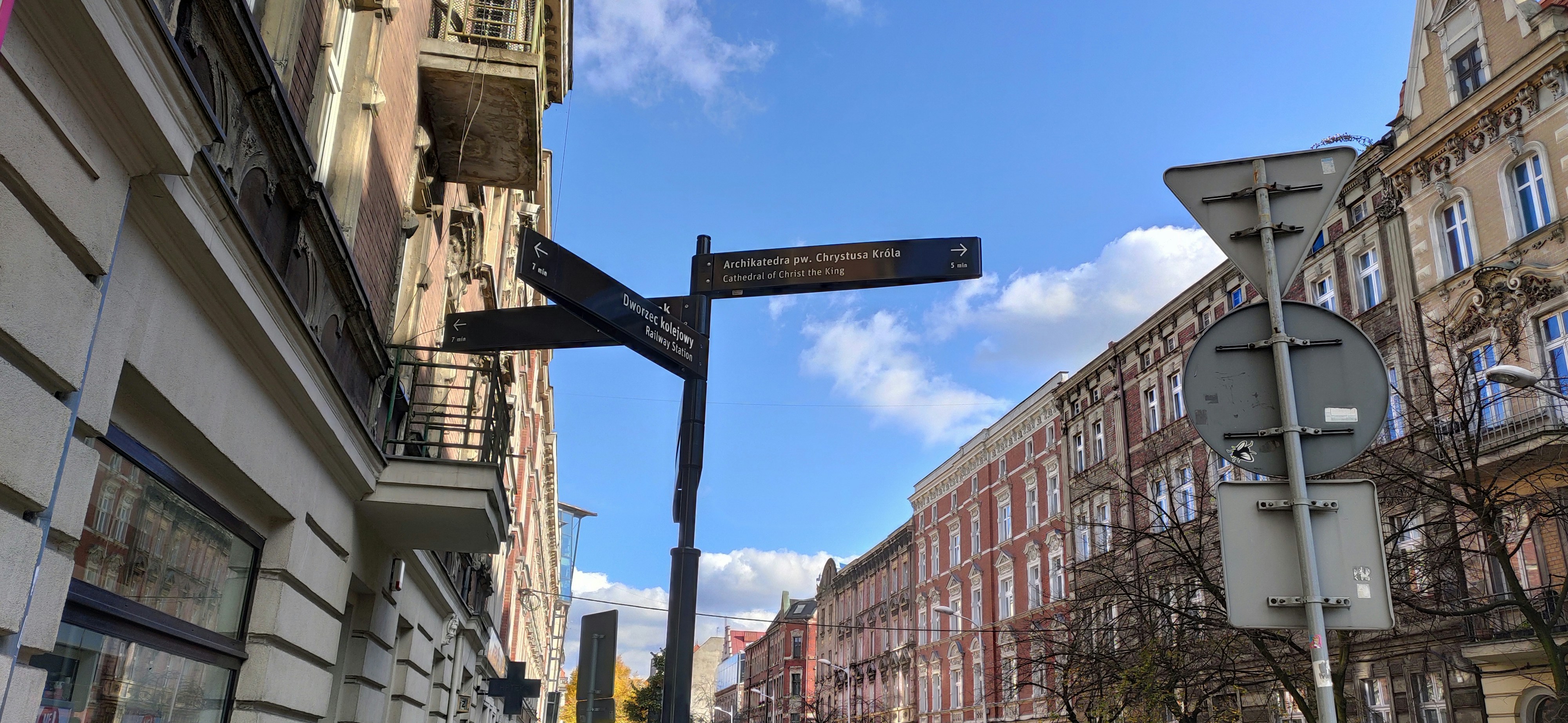 A street sign in front of a building photo – Free Katowice Image on ...