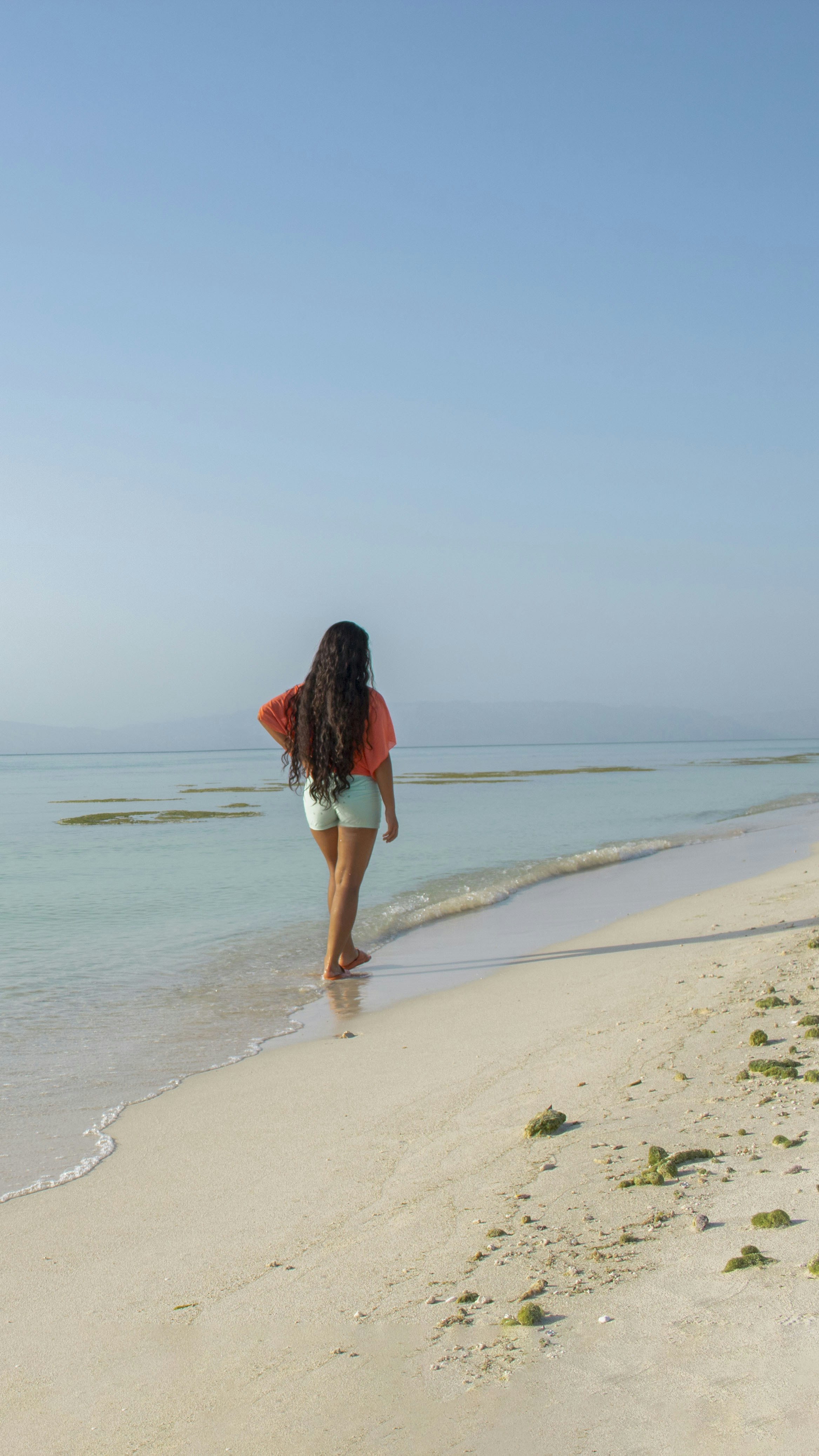 a person walking on a beach