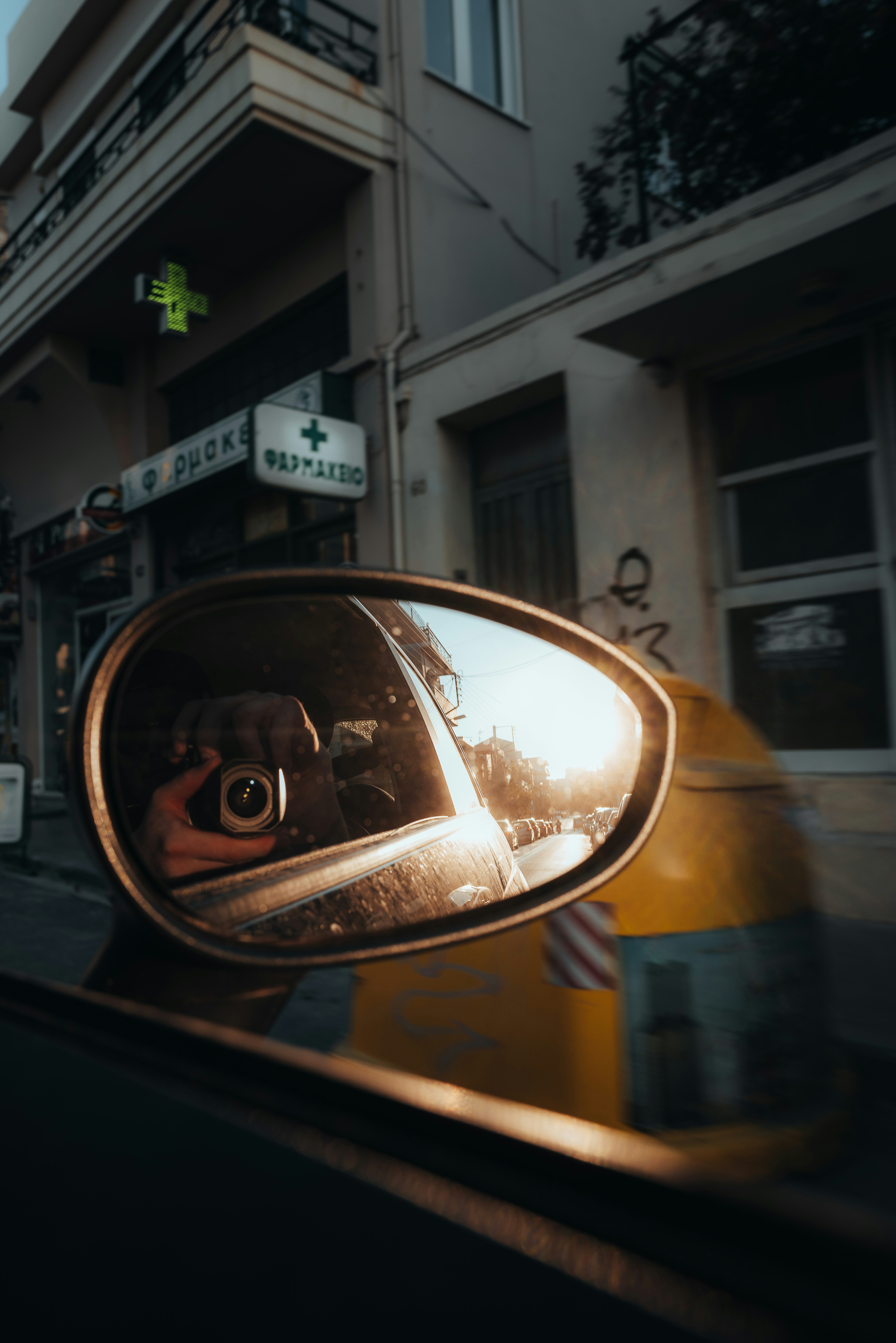 a person taking a picture of themselves in a car mirror