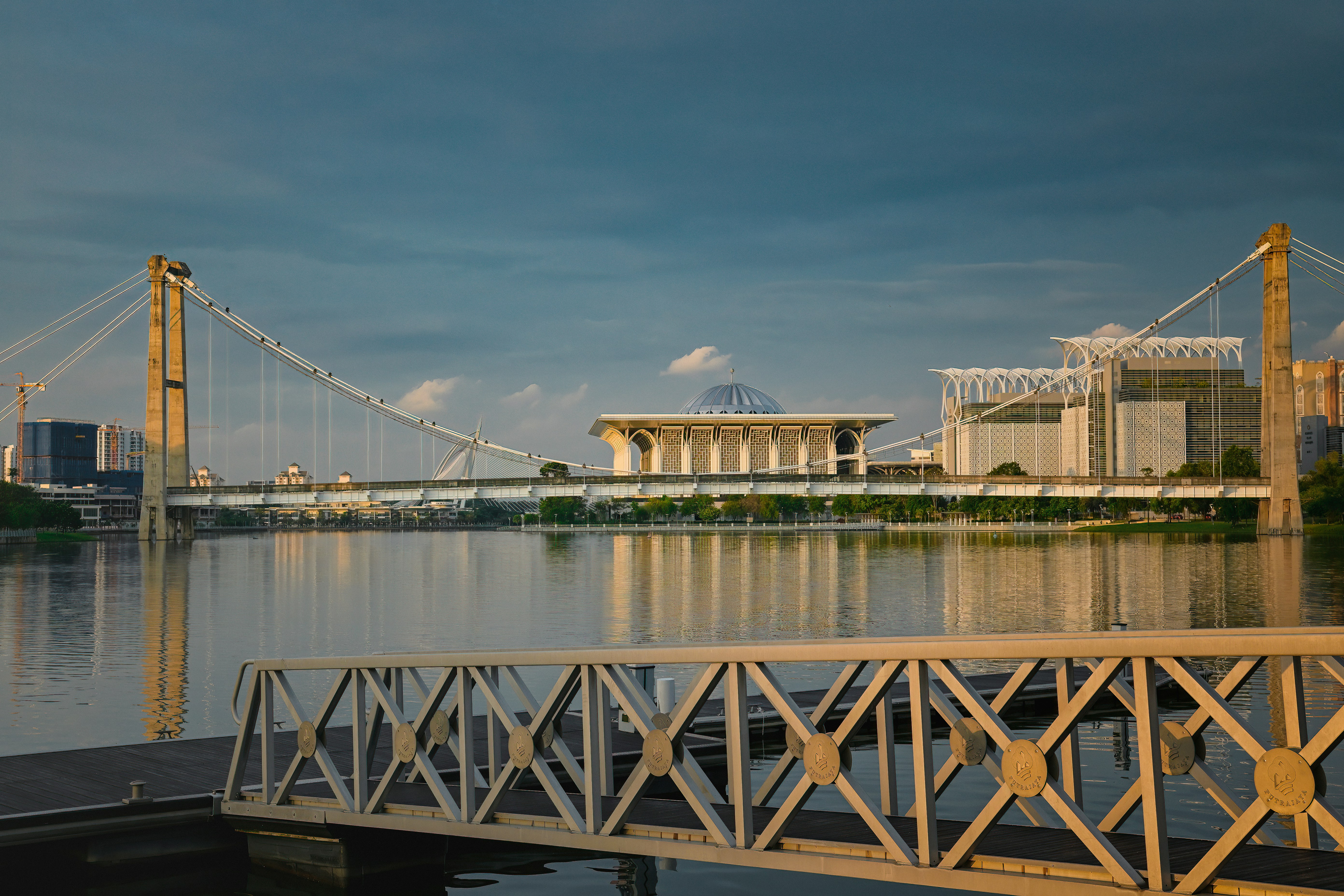 a bridge over water with a building in the background
