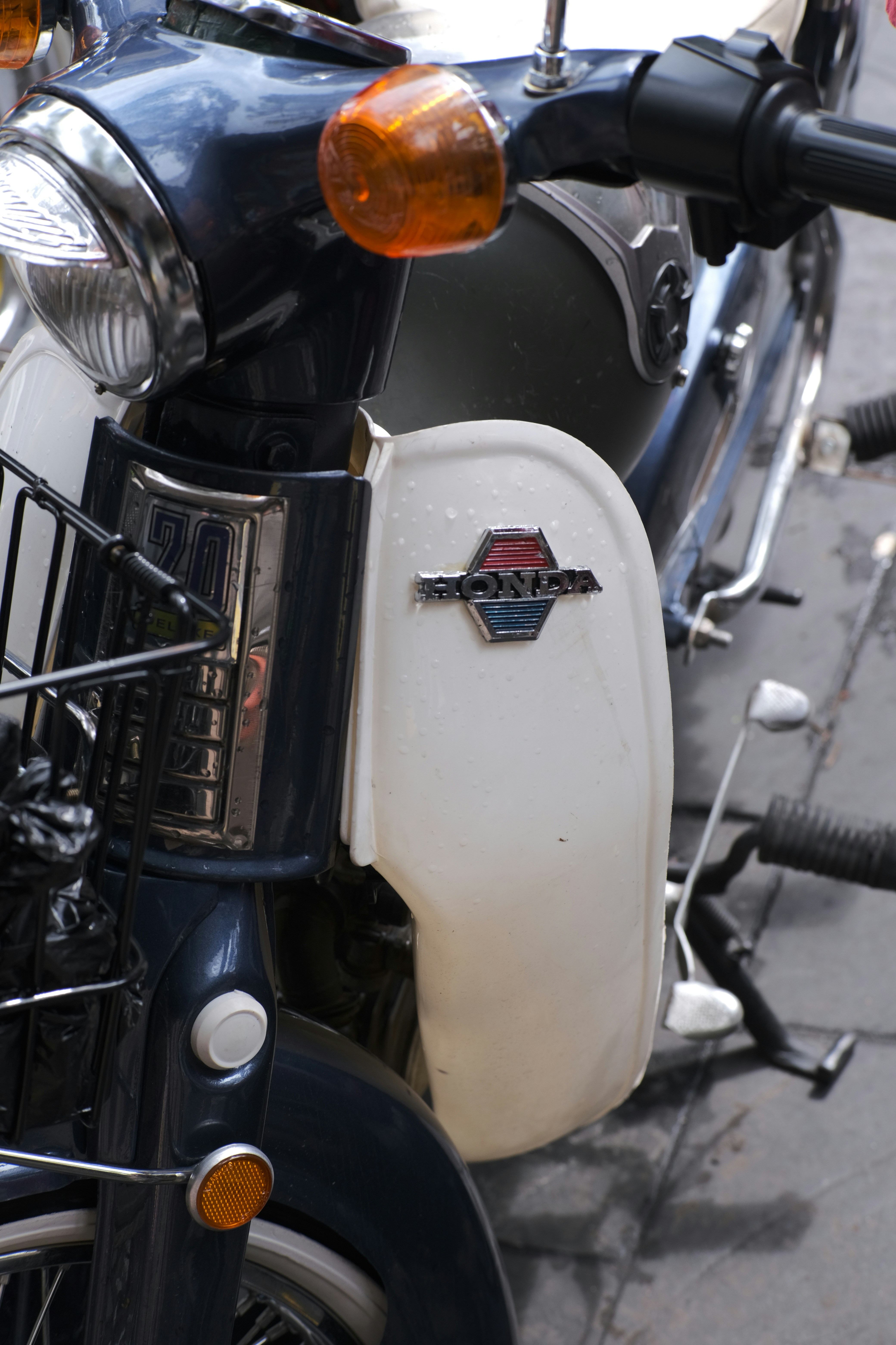 Emblem in Cream: A Vintage Honda Front Panel Close-Up