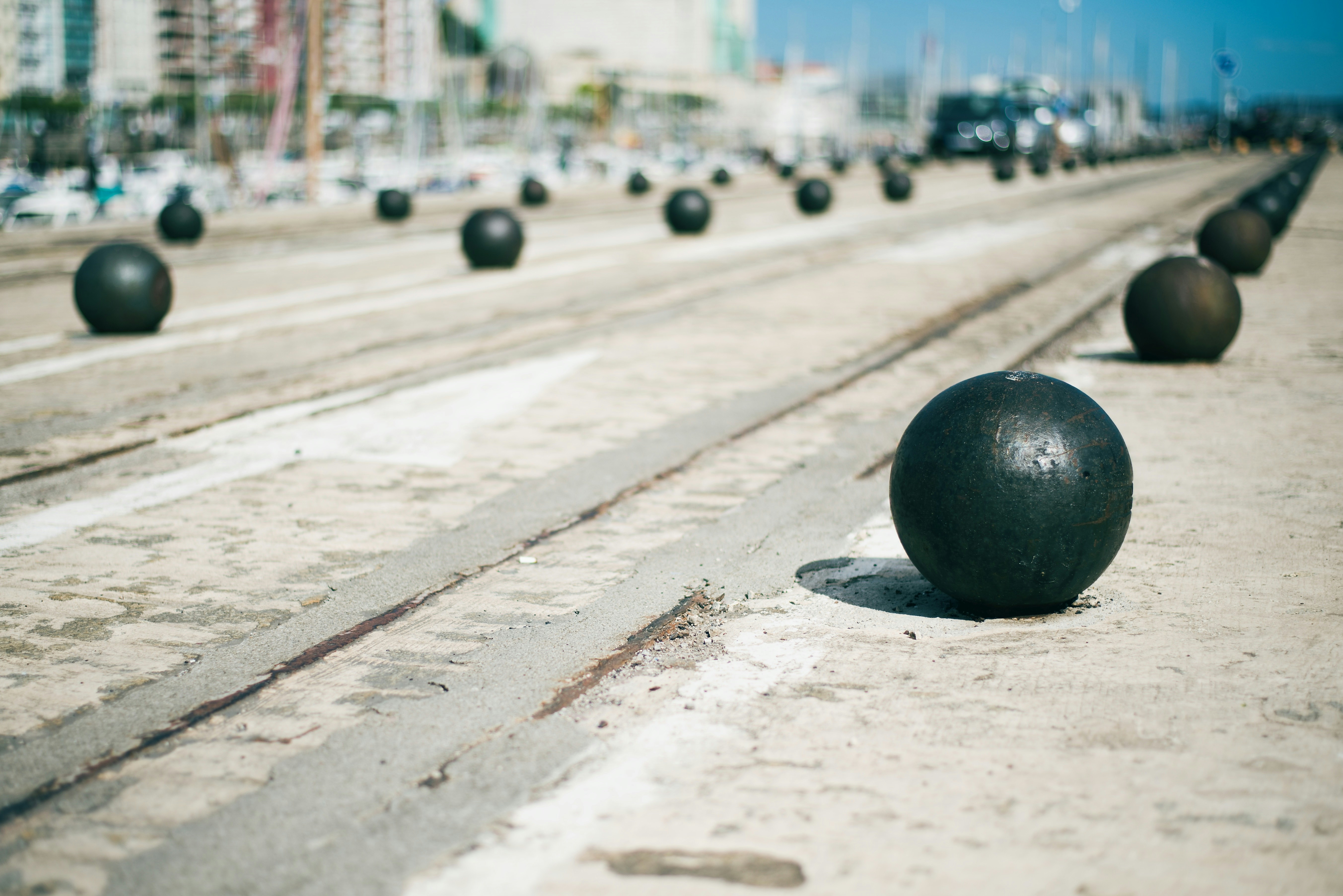 Row of Maritime Boules: Echoes of a Pier in Distant Blur