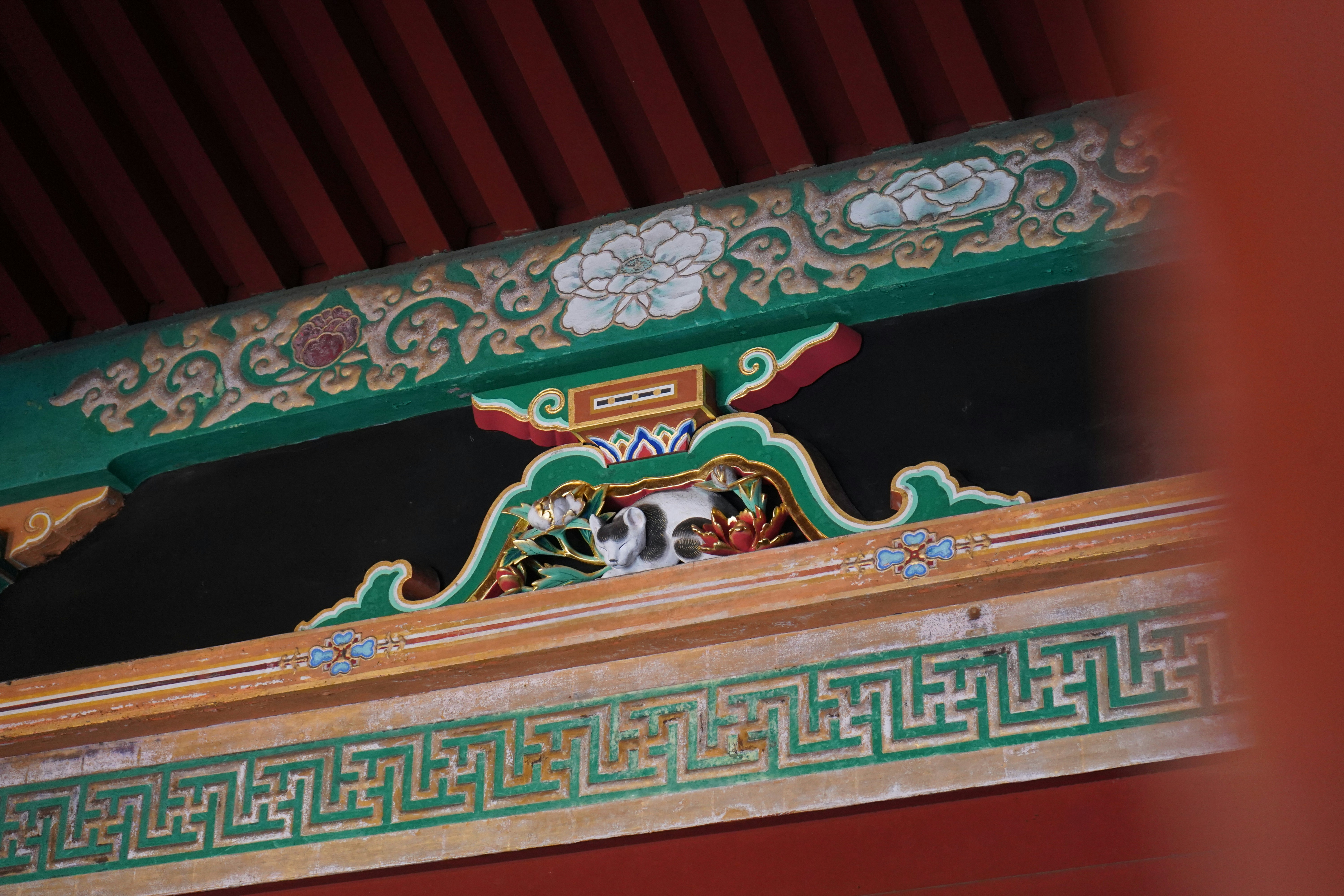 Ornate Temple Frieze: A Glimpse Through The Slats