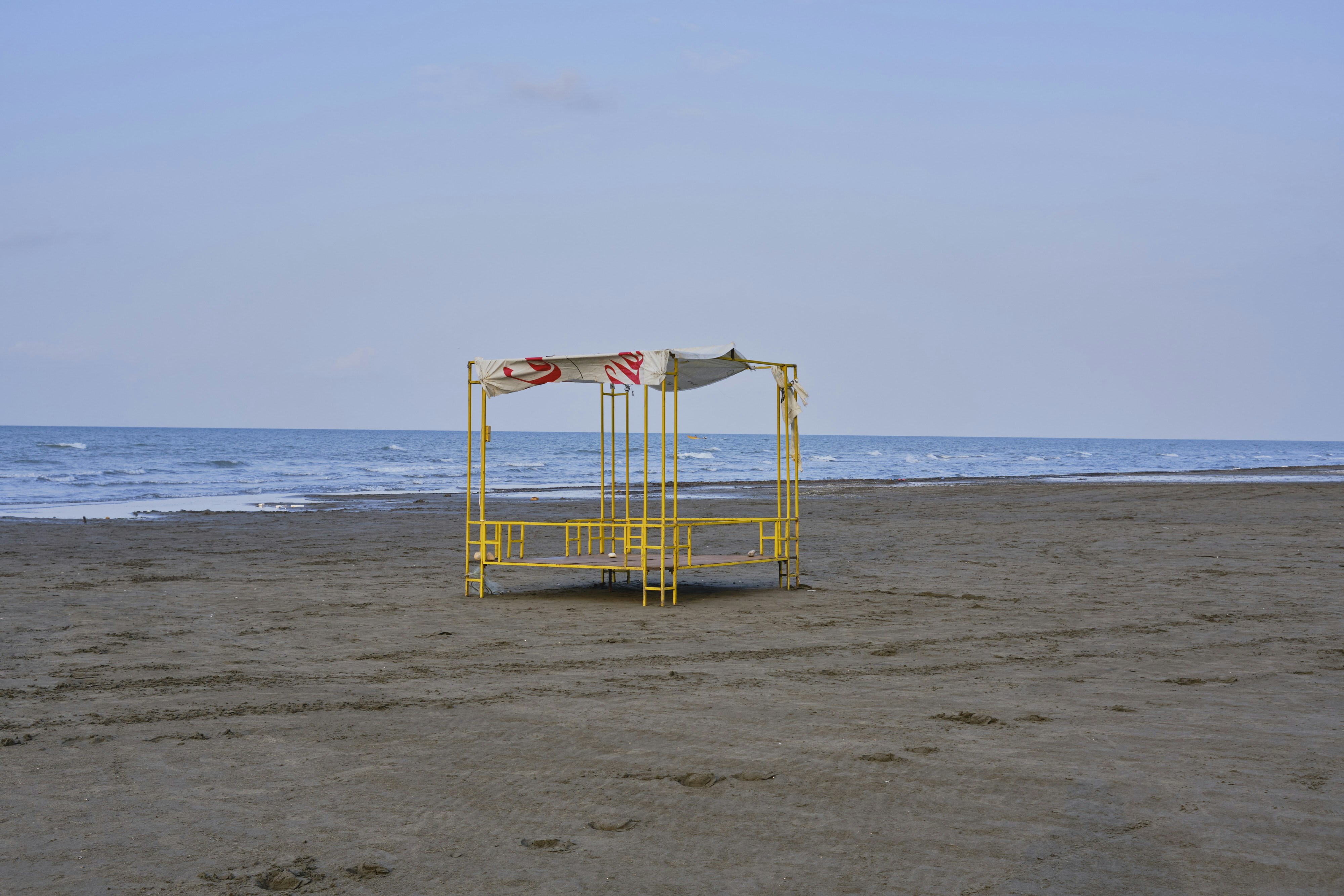 a yellow structure on a beachAlireza Banijani