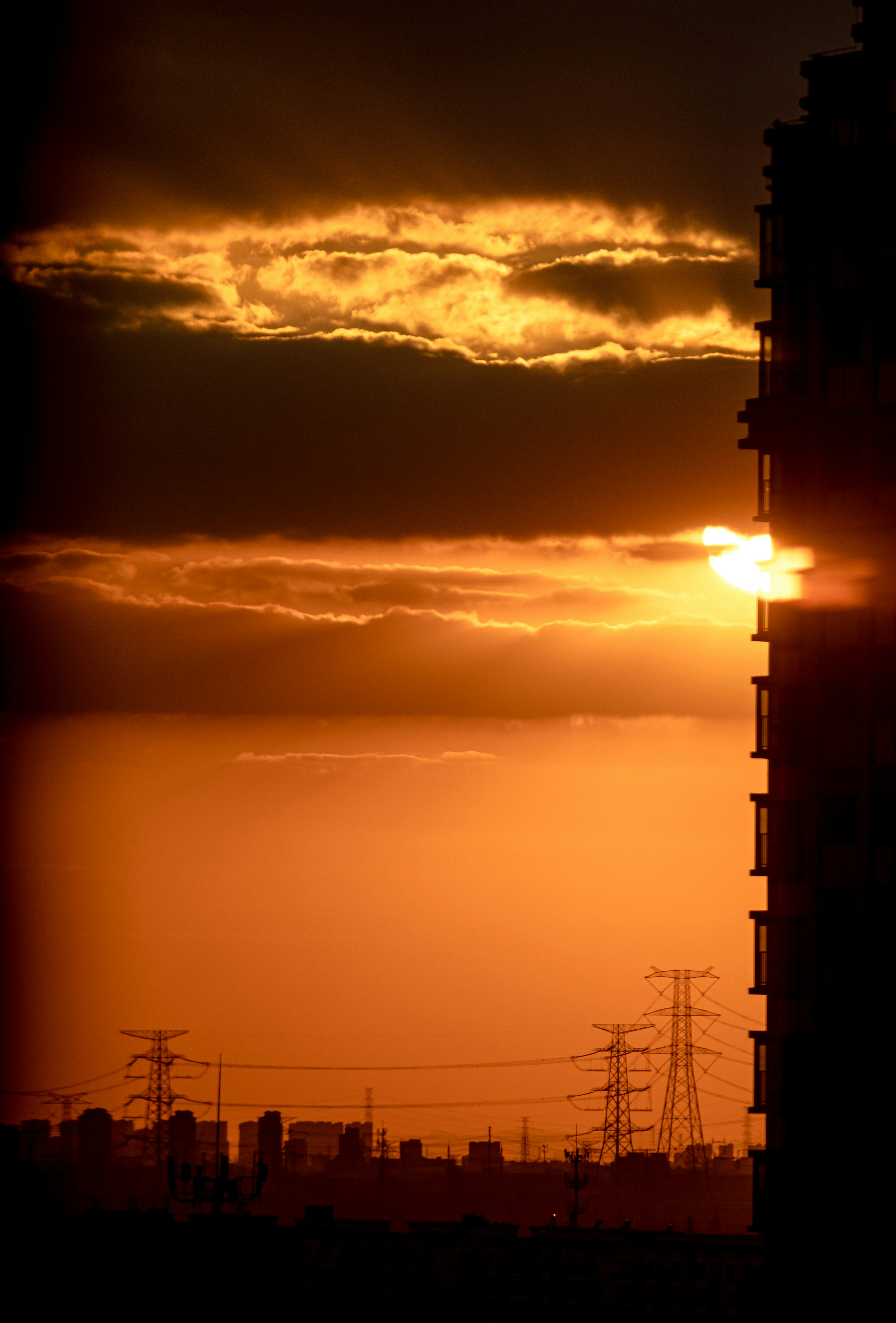 a sunset over power lines