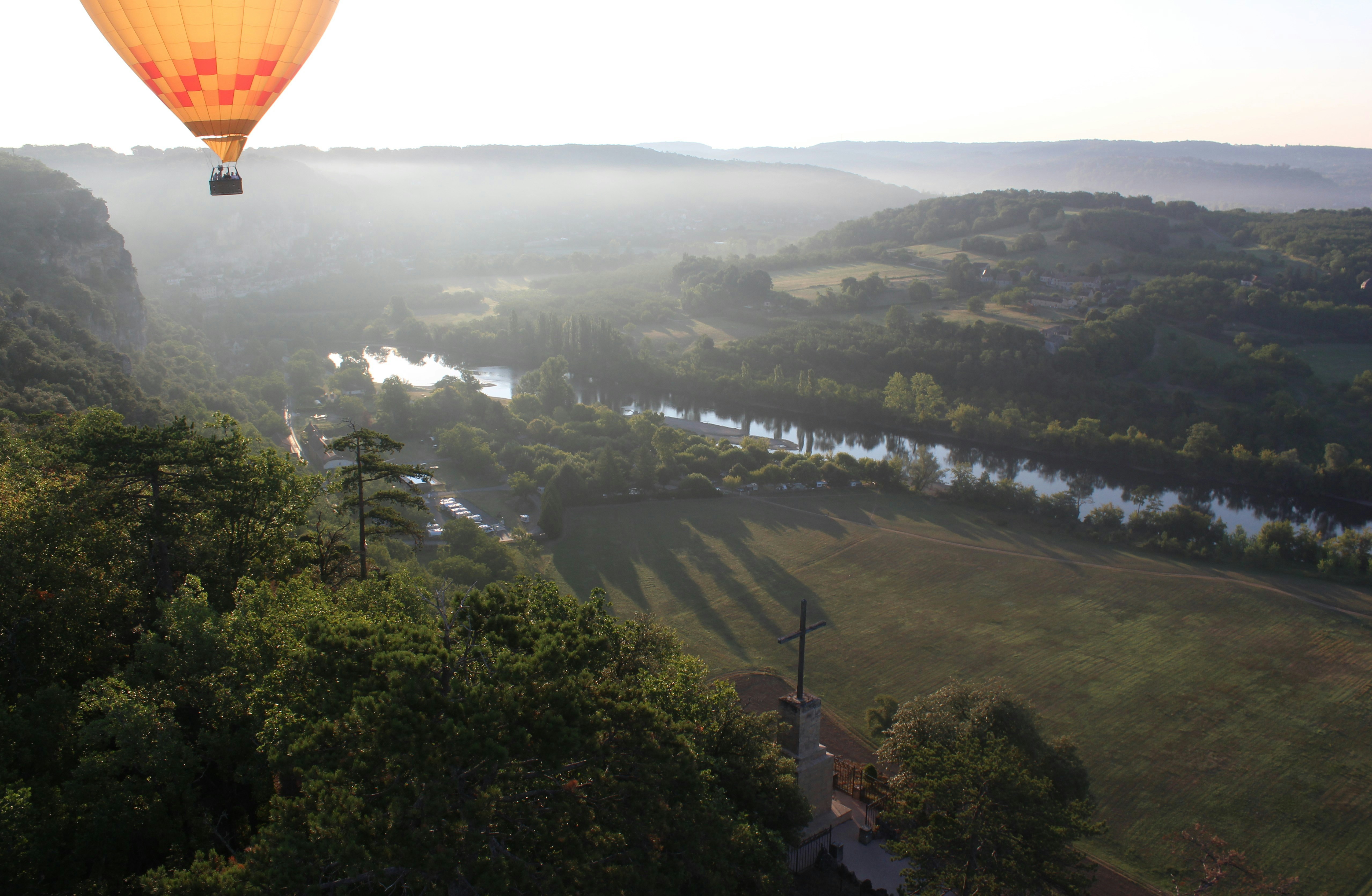 Dawn Ascent: A Lone Balloon Skims the River Valley