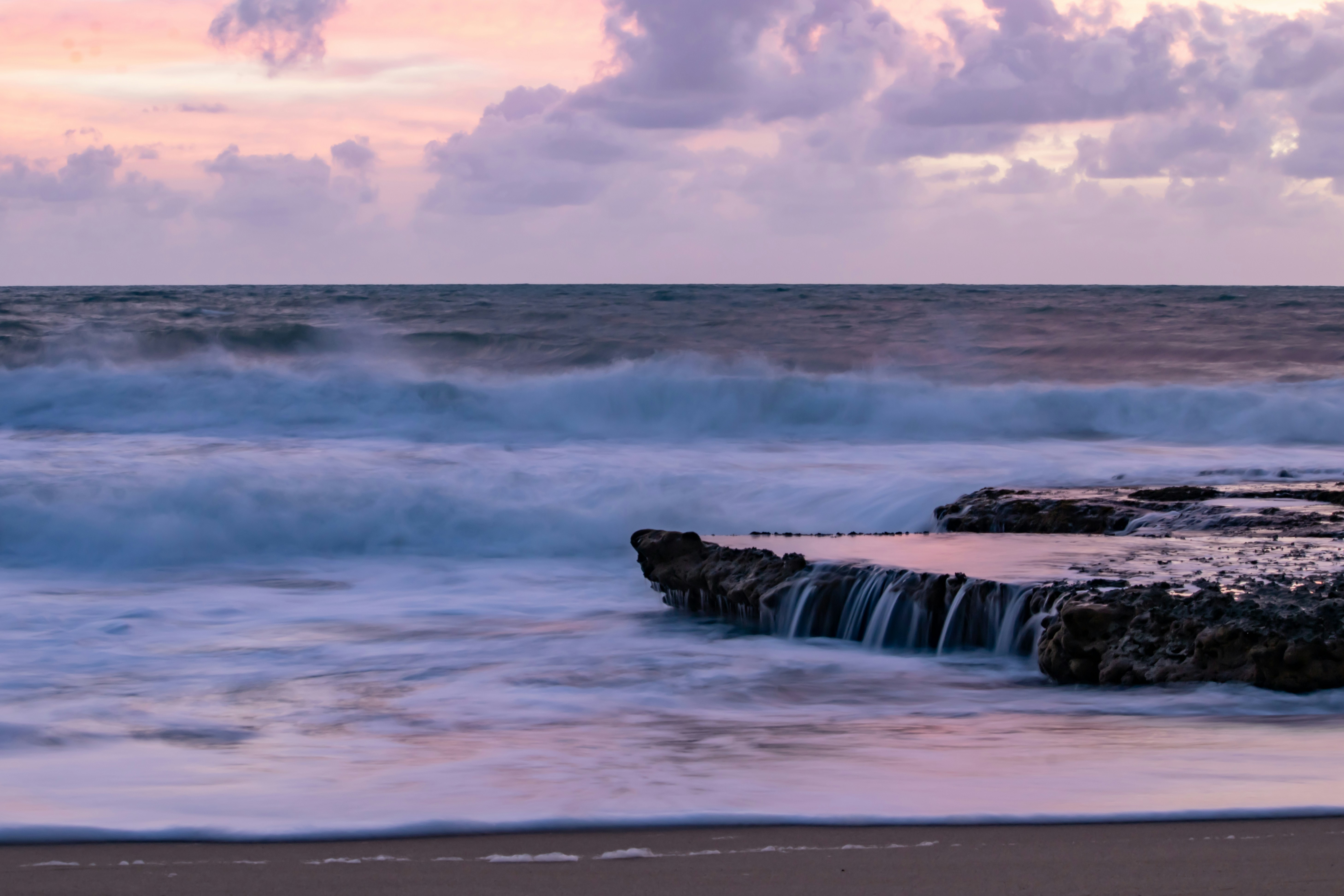Edge of Light: Pink Dusk Over a Quiet Seaside Ledge