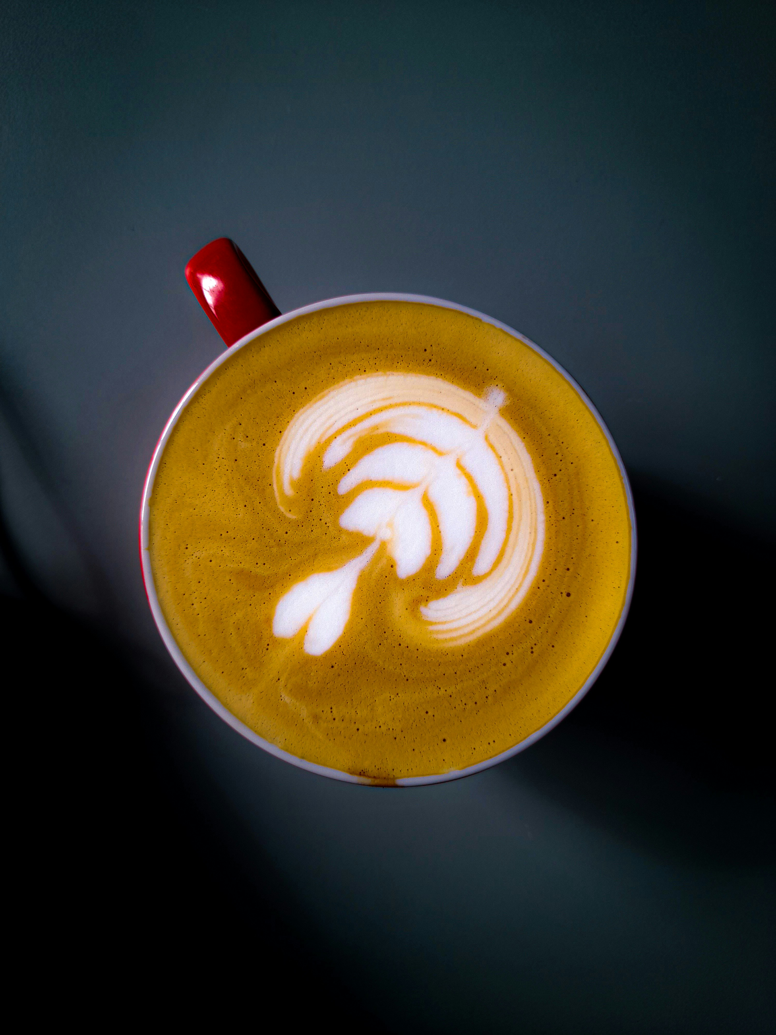 a tea cup with a red spoon
