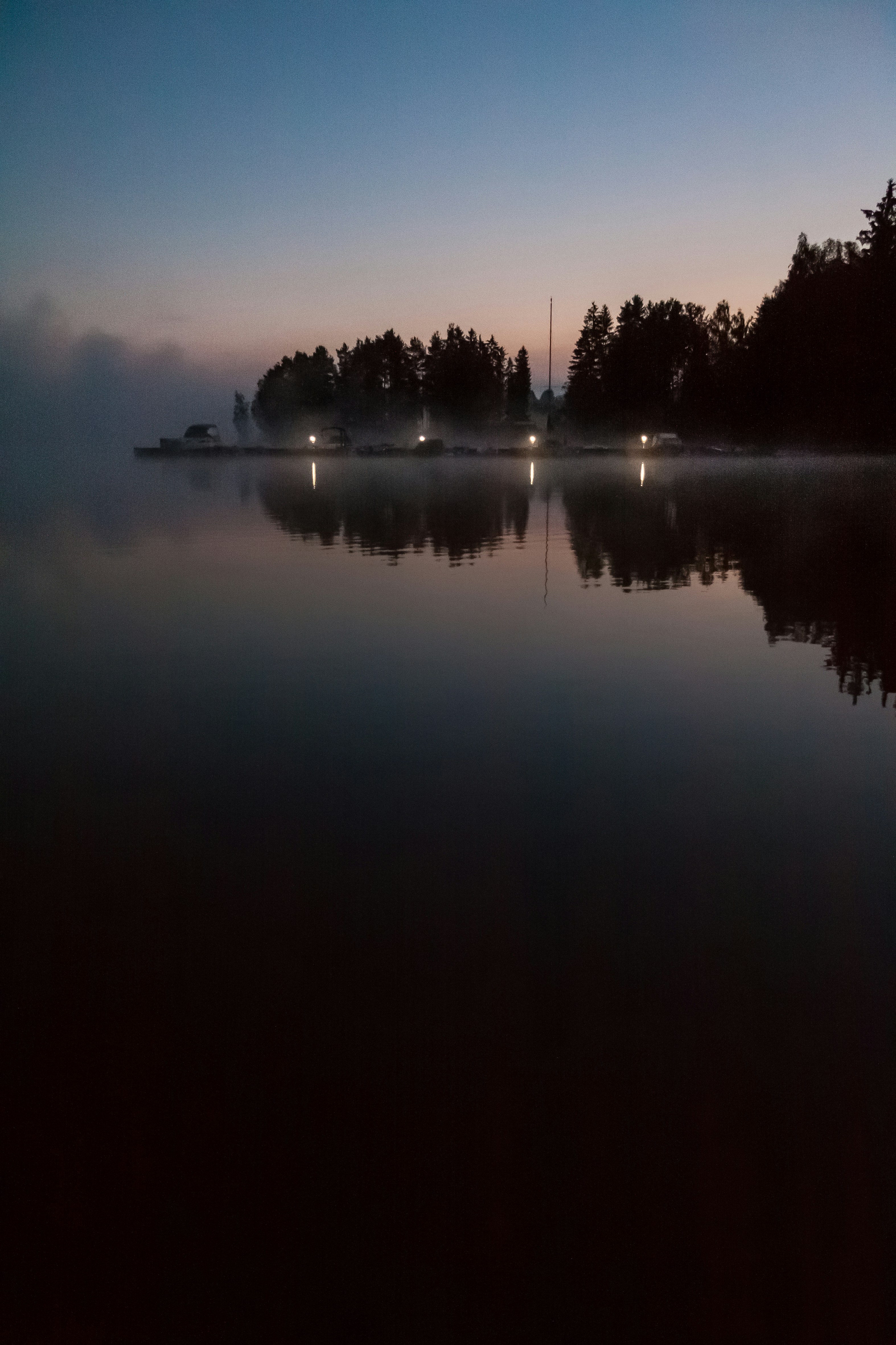 Blue Hour Lanterns on a Misty Lakeshore