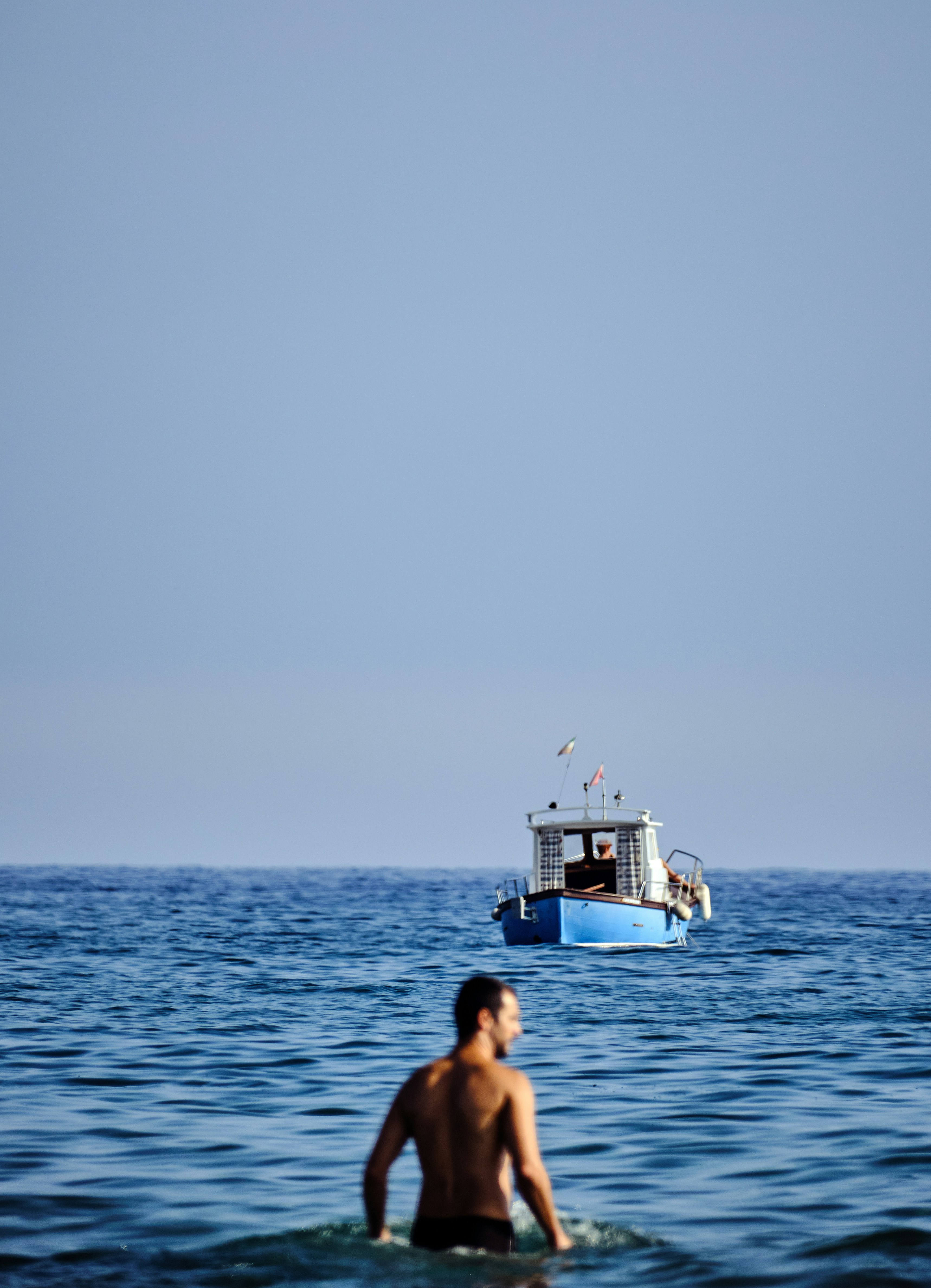 Blue Skiff on the Horizon: A Solitary Swimmer in the Open Sea