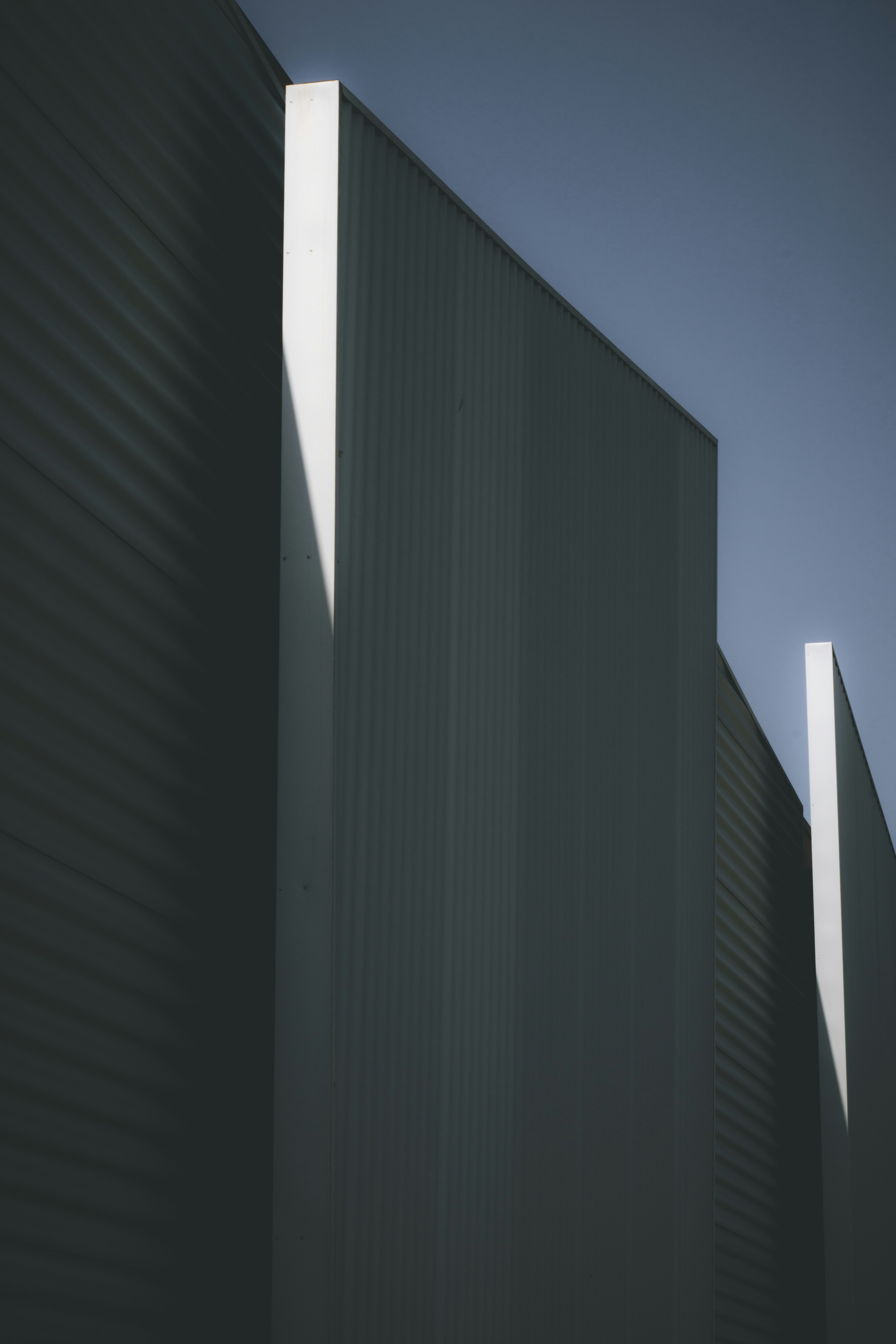 Light-Cast Columns Along a Quiet Industrial Facade