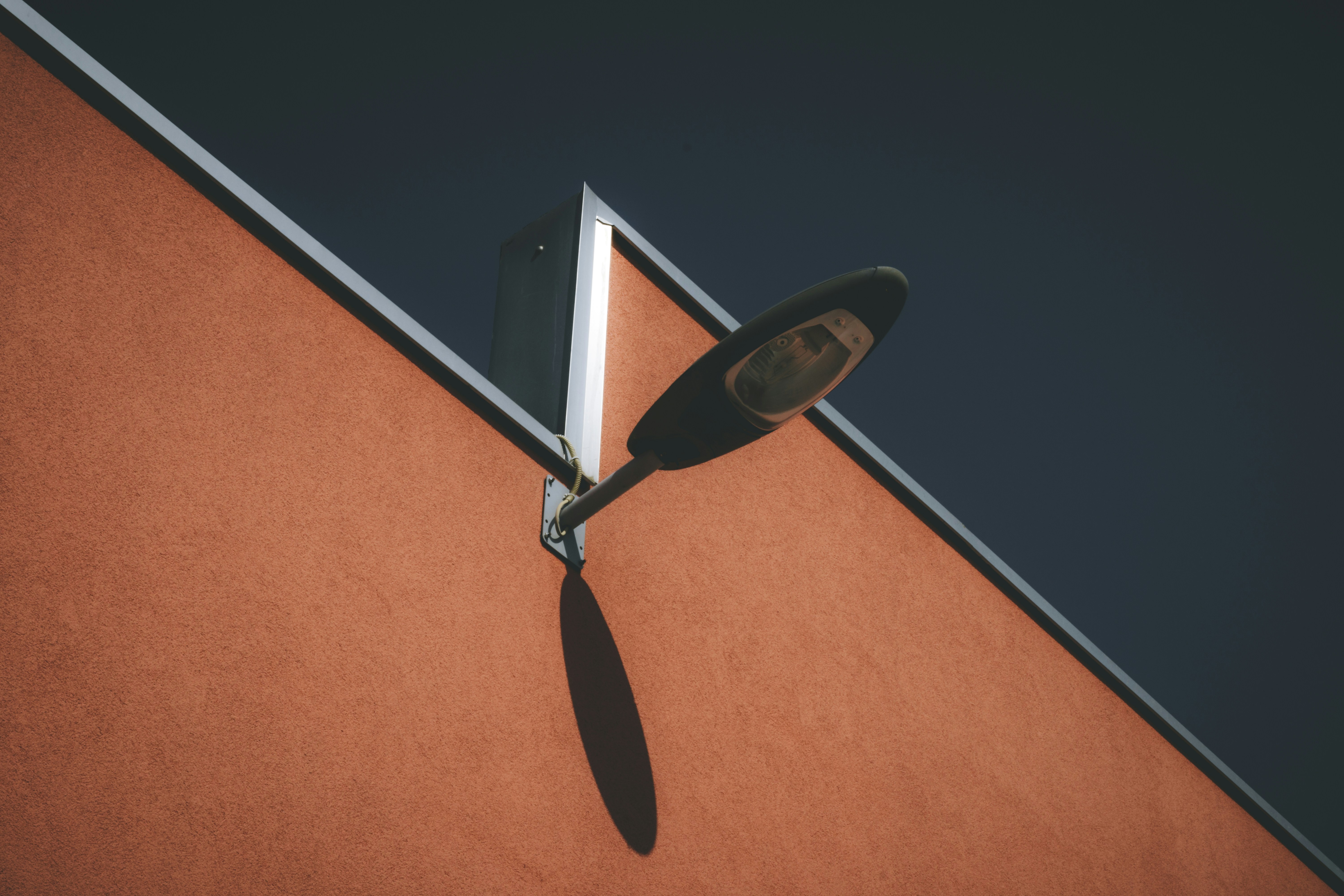 Ellipse of Shadow: Geometry of a Streetlamp on a Tangerine Wall
