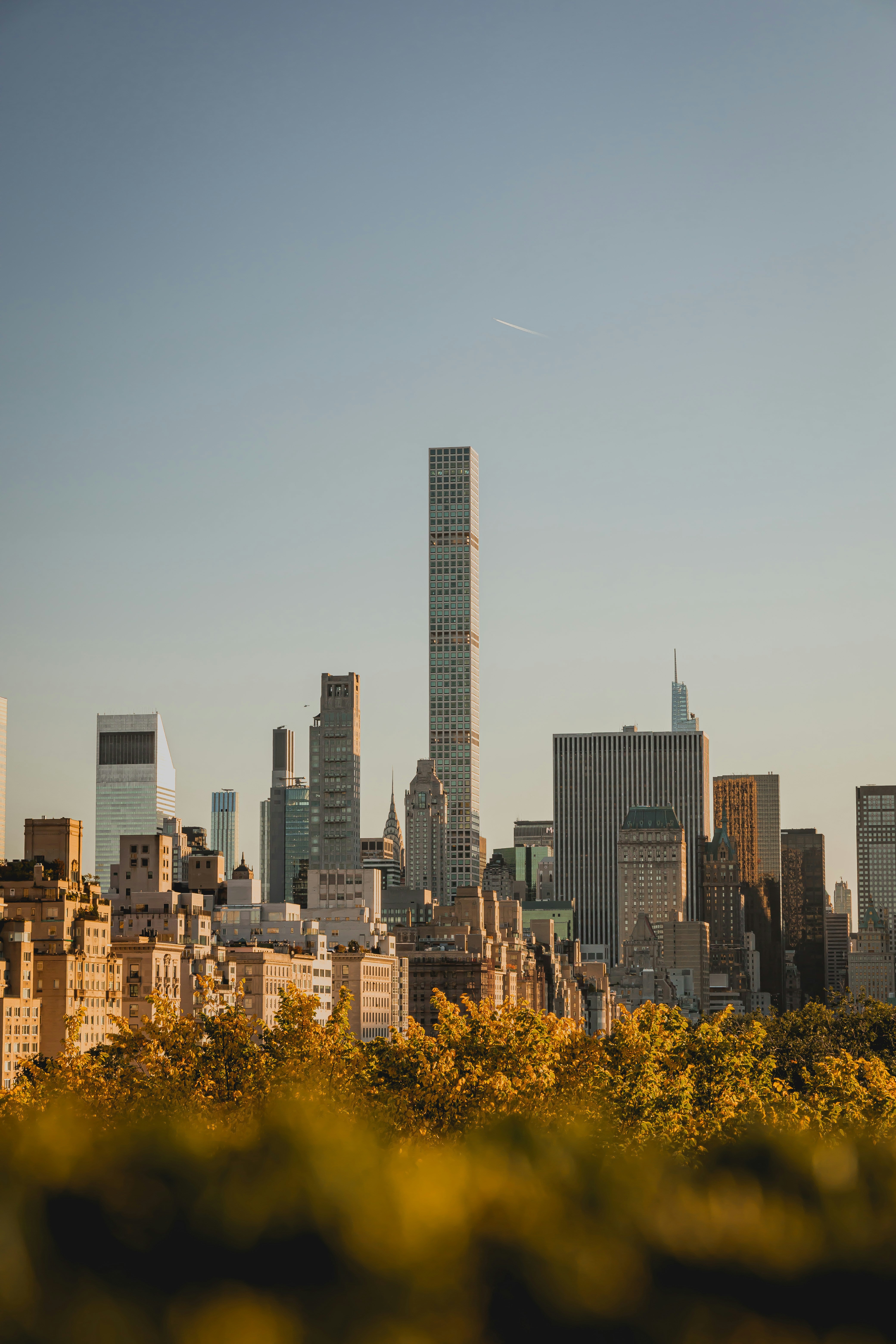 Slim vertical sentinel over a honeyed Manhattan skyline at golden hour
