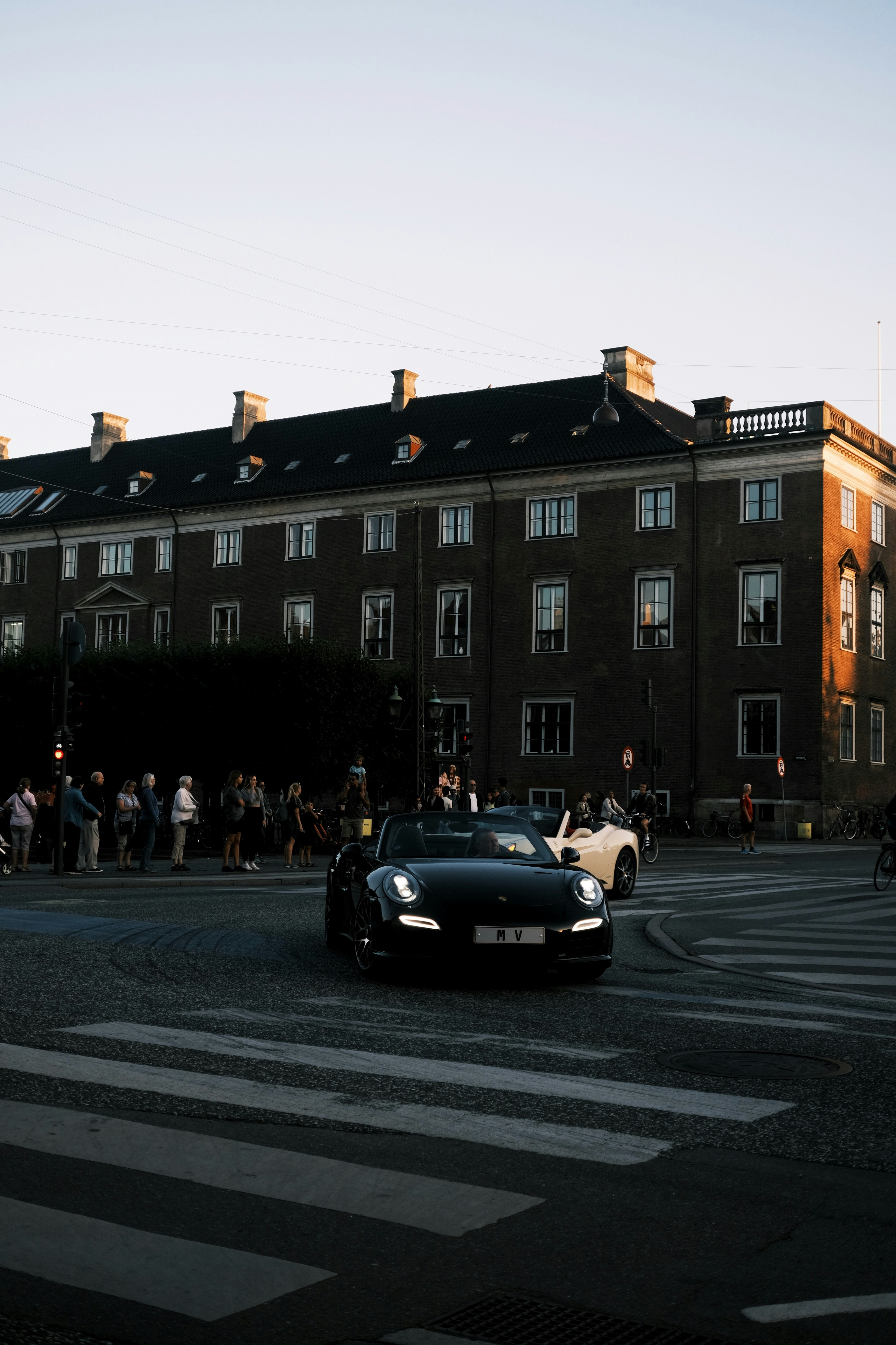 Dusk Crossing: A Noir Convertible Navigates the City Intersection