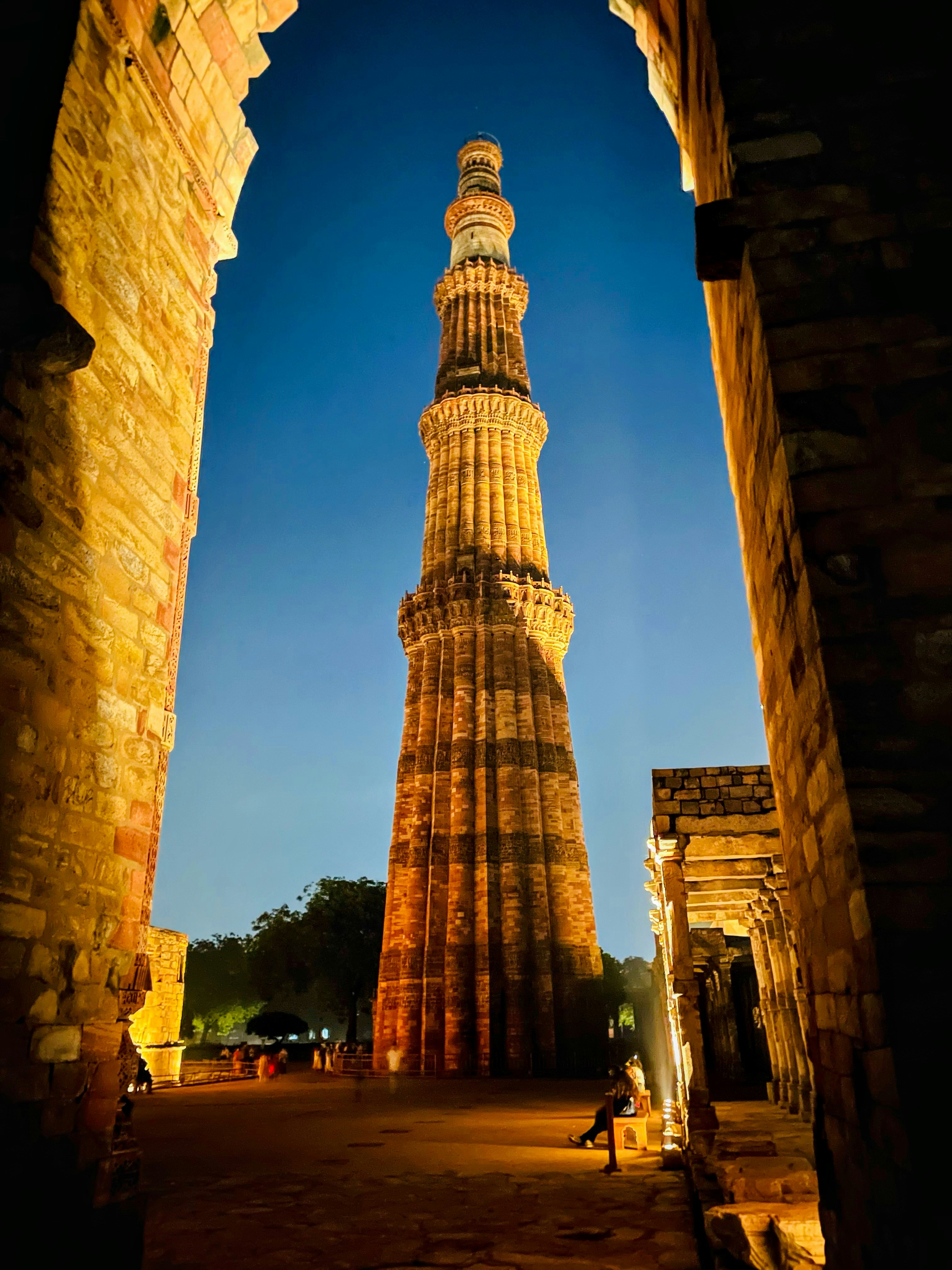 Towering Silhouette: Sunrise Light on the Qutub Minar Corridor
