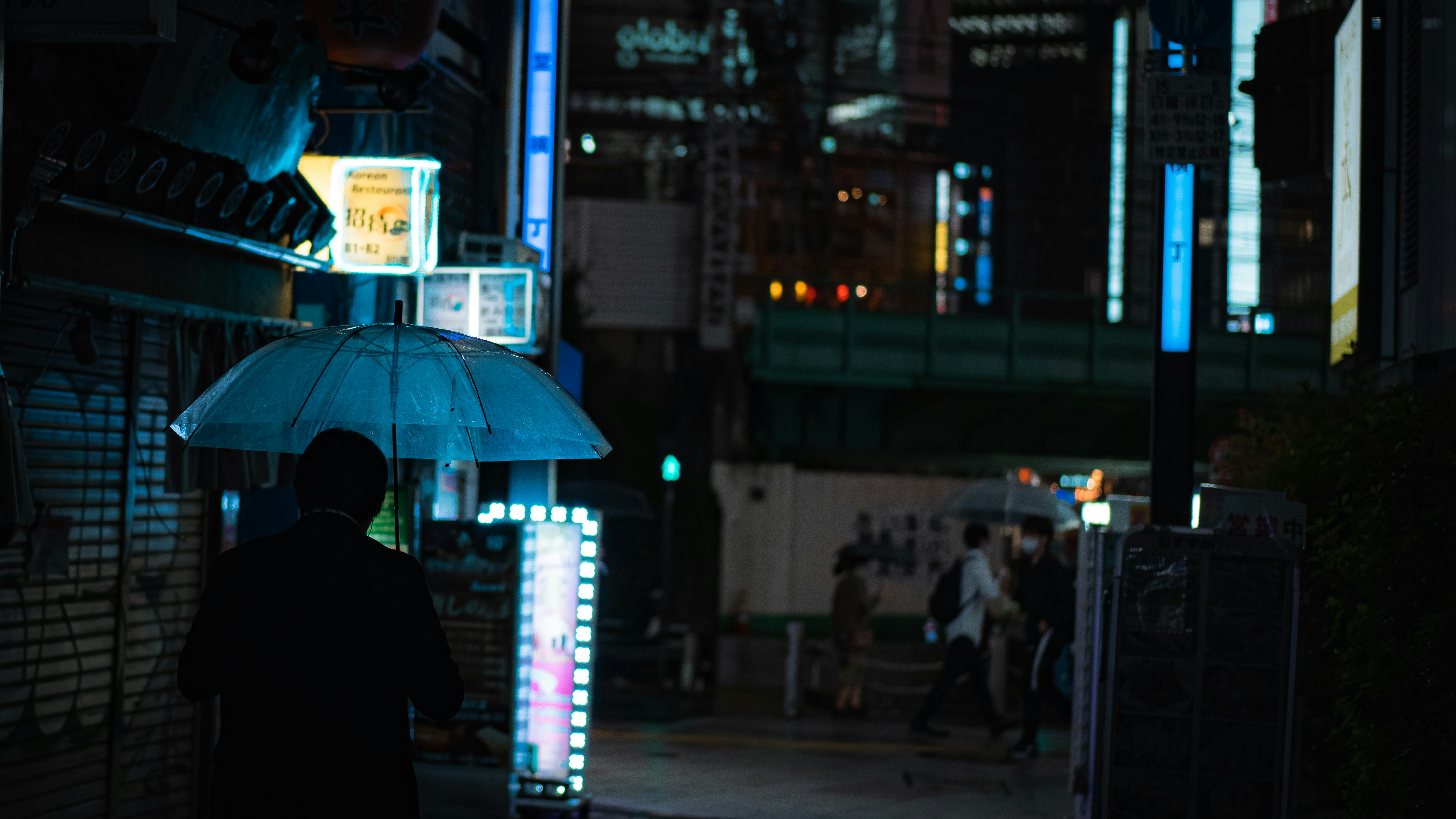 Umbrella Night: A Quiet Figure in Neon Alley
